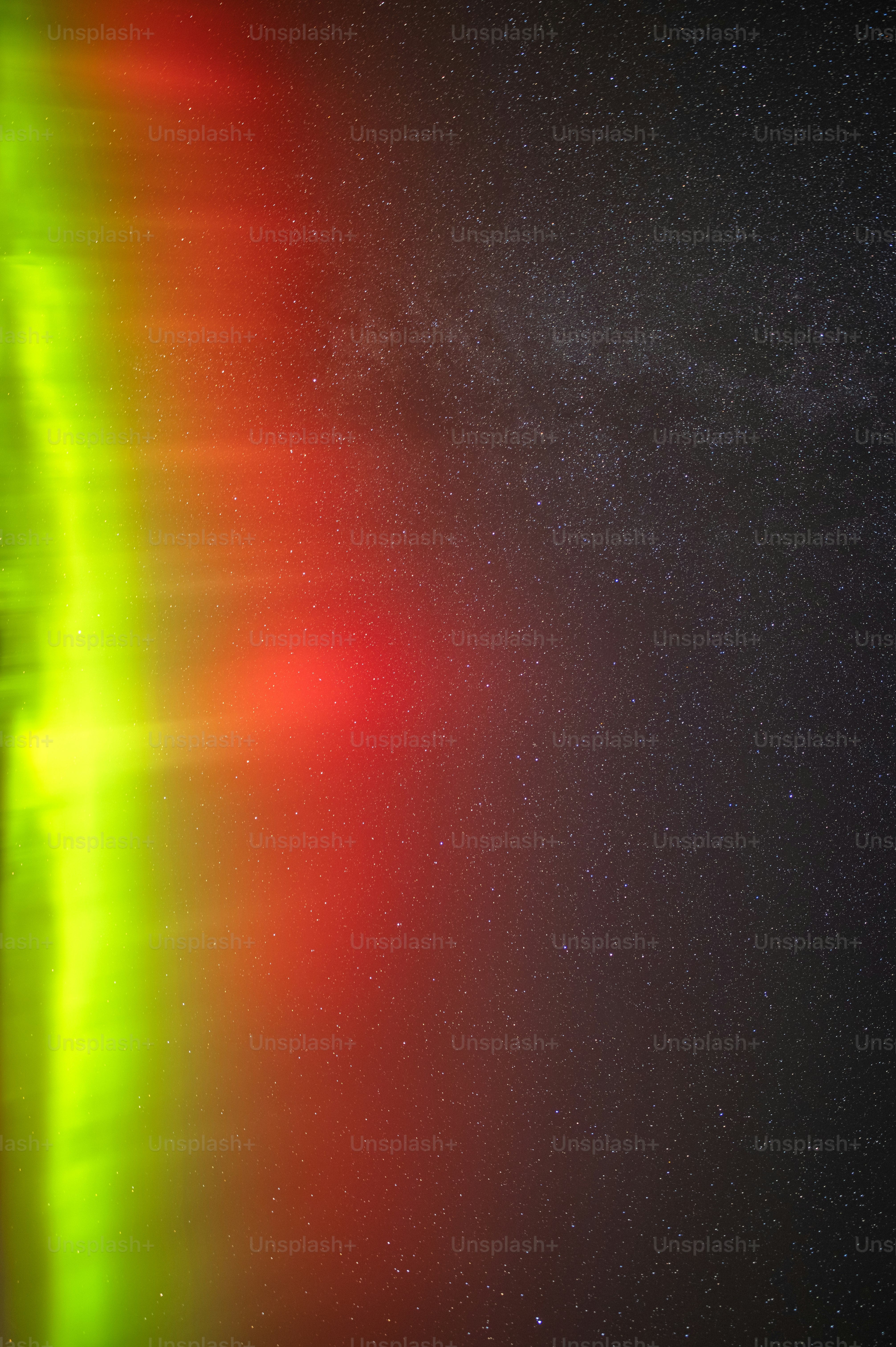 A bright green and red light shines brightly in the night sky photo ...