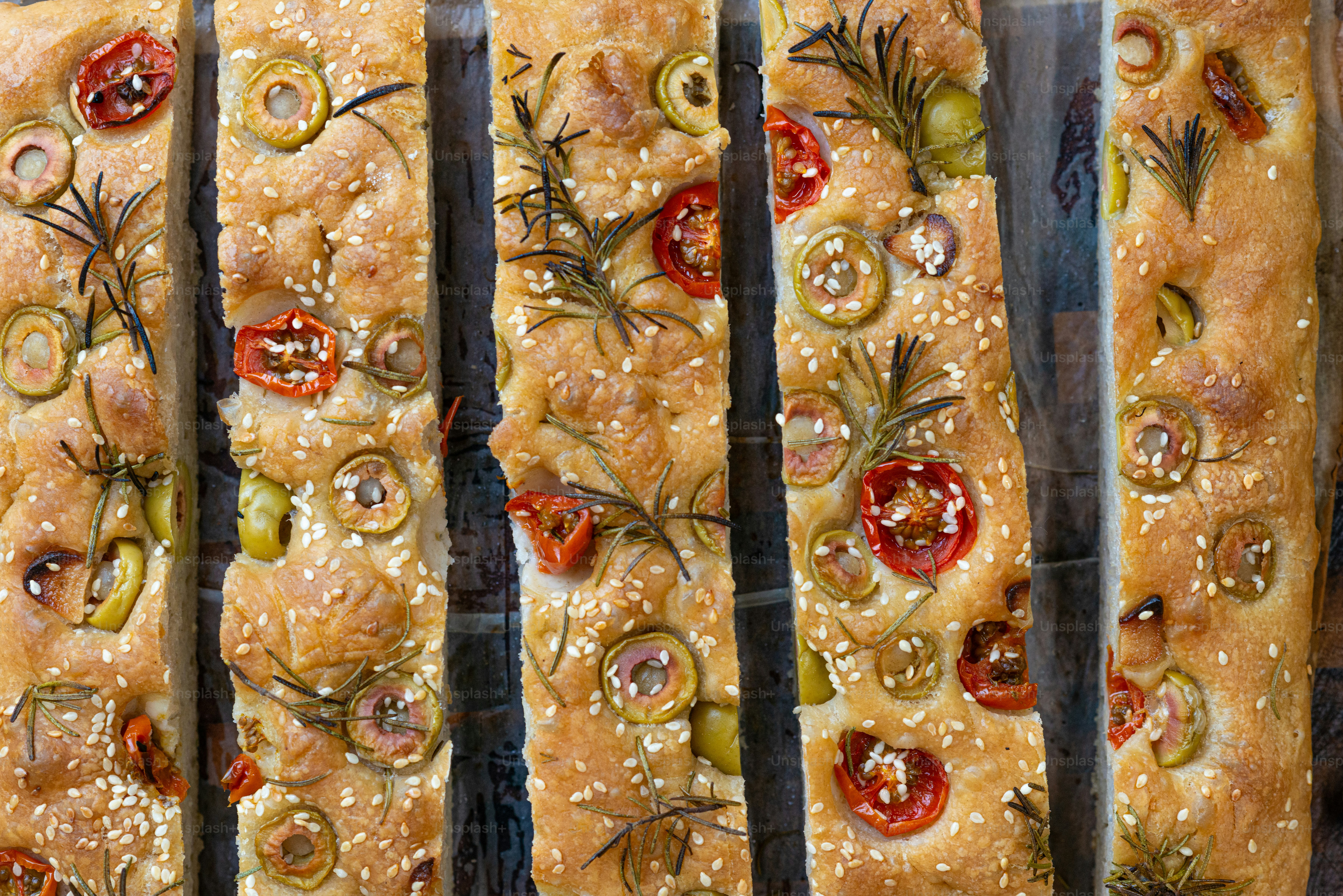 A close up of a bread with toppings on it photo – Focaccia Image on ...