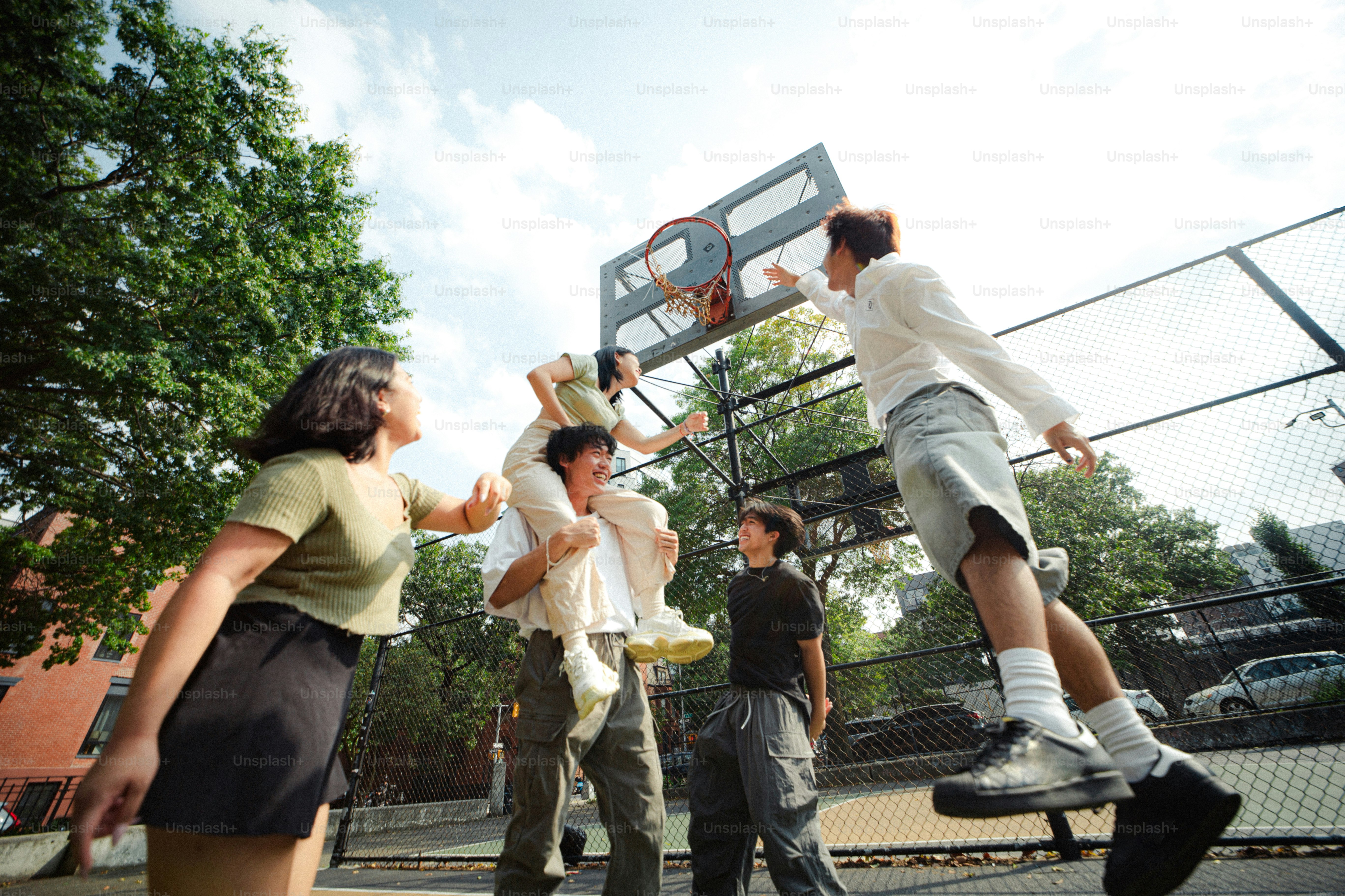 A group of young men playing a game of basketball photo – Friendship ...
