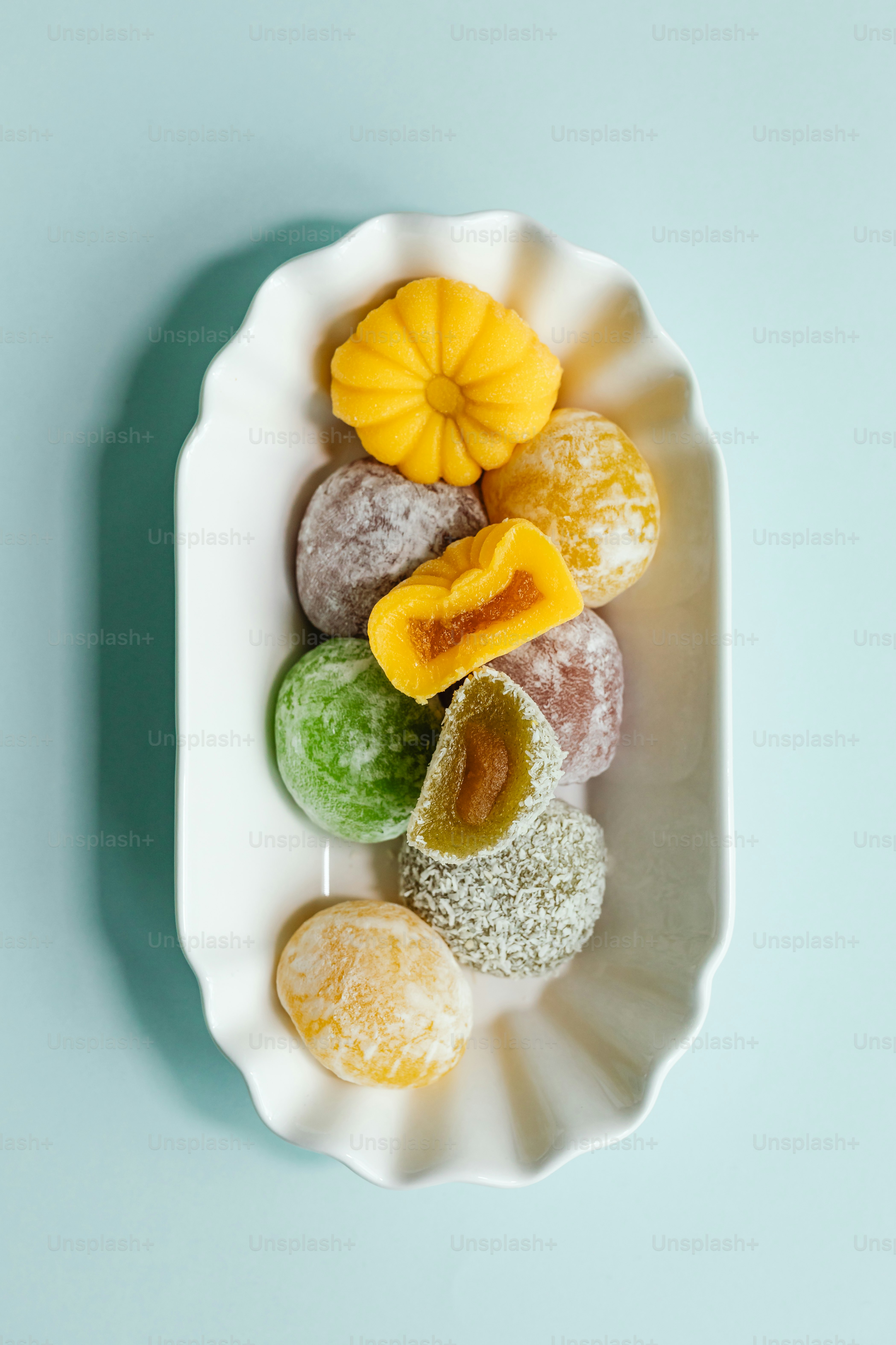 A white plate topped with different types of candies photo – Food Image ...