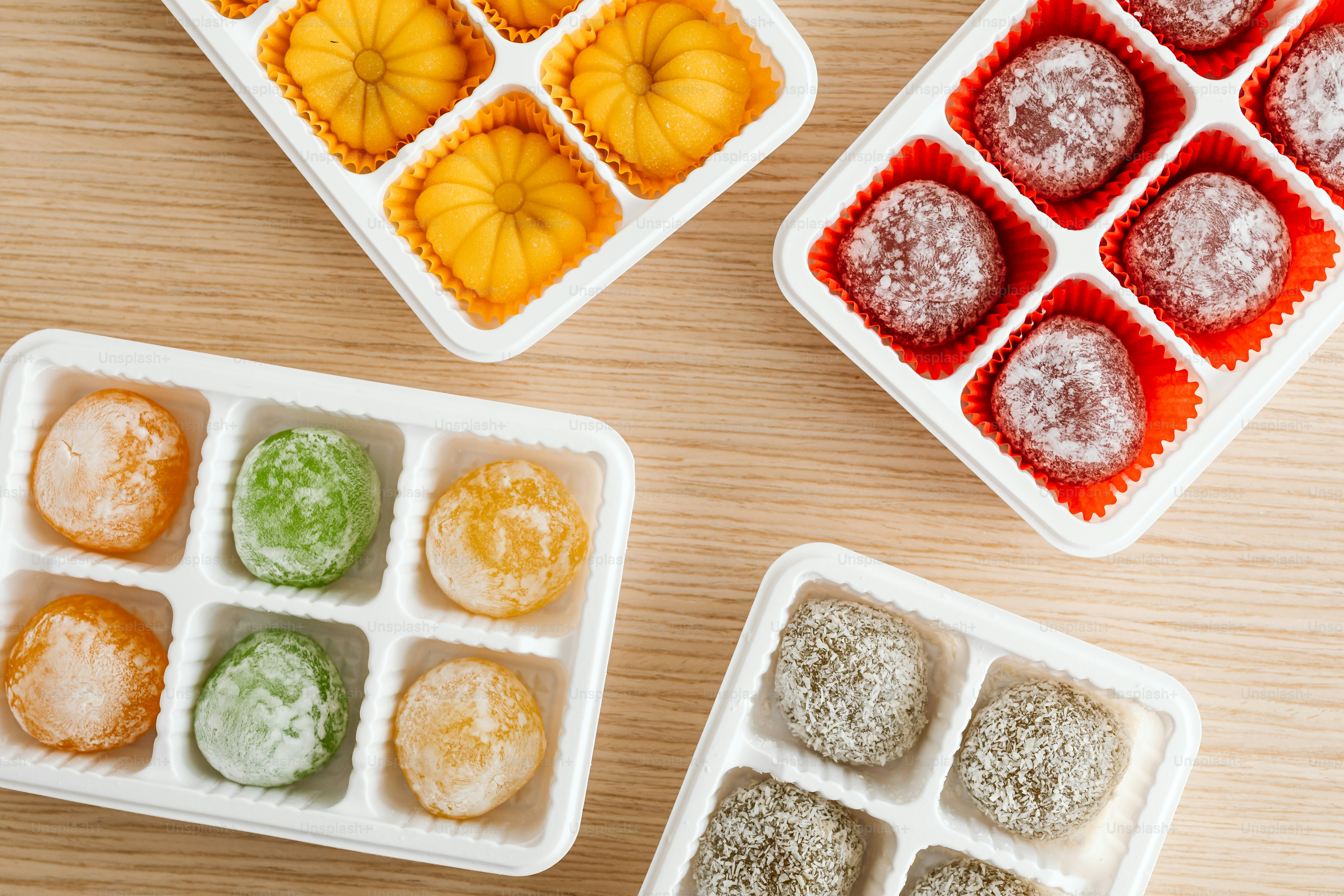 A couple of trays filled with different types of pastries photo ...