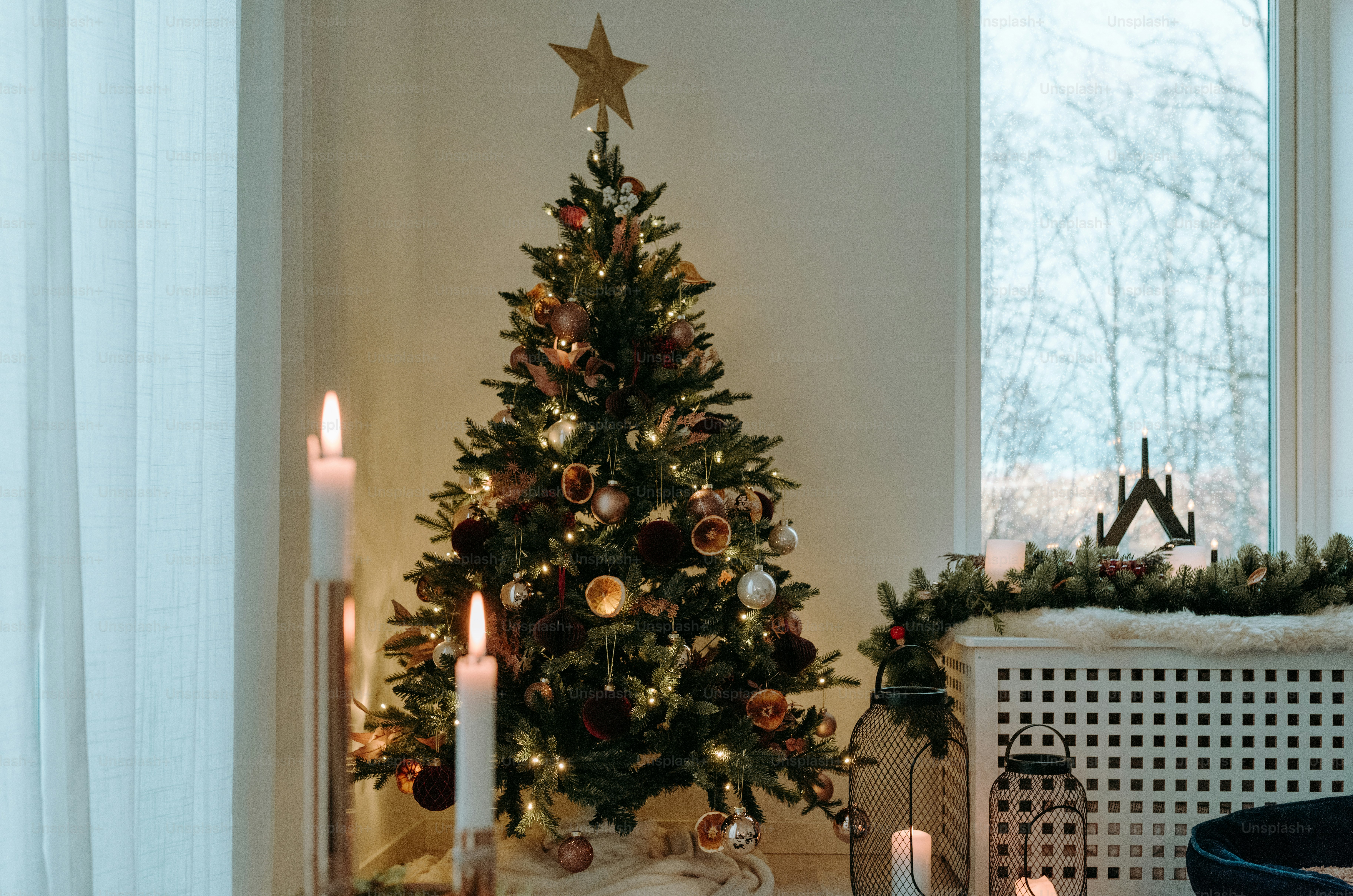 A decorated christmas tree in front of a window photo – Christmas tree ...