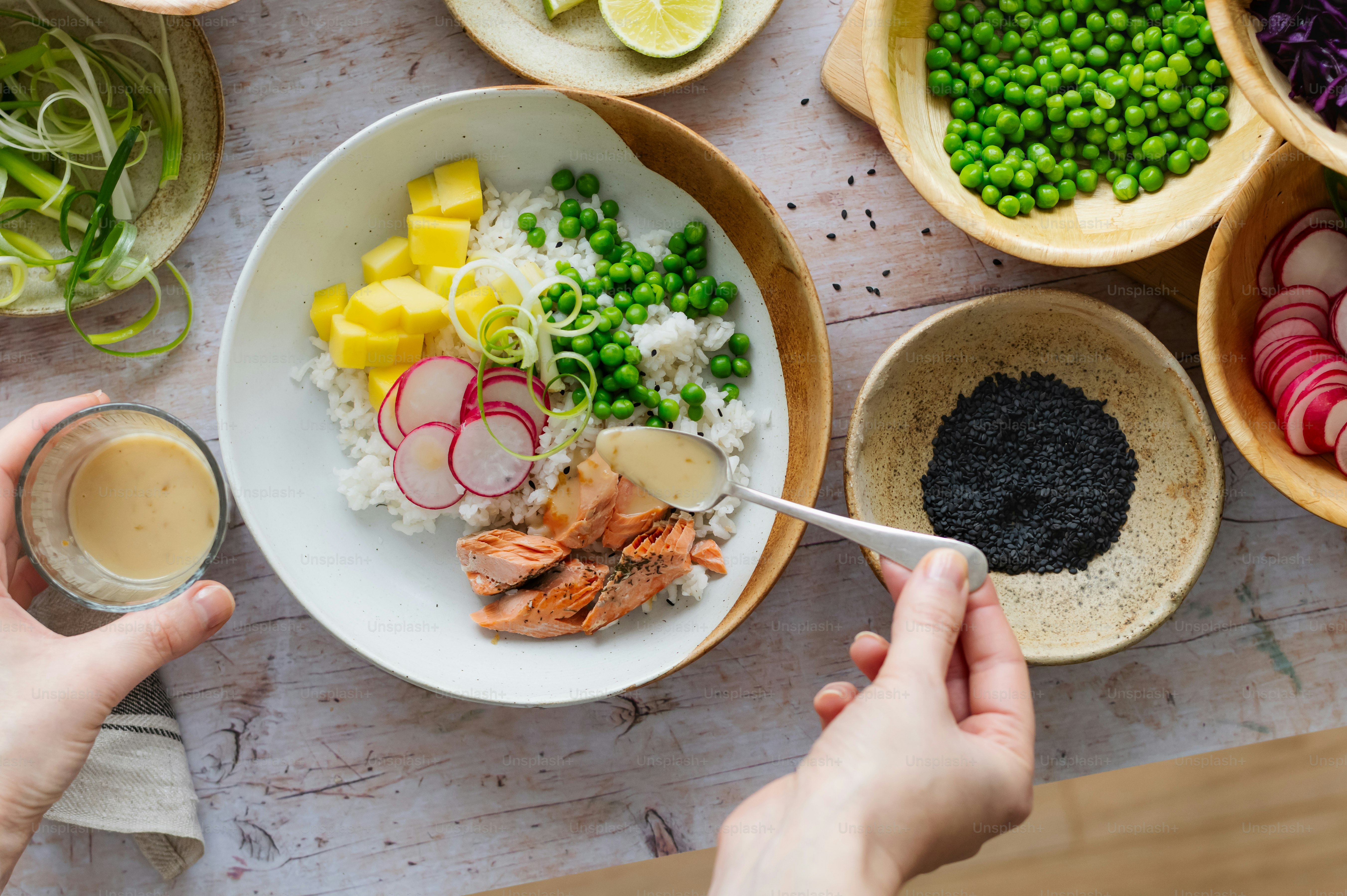A person eating a bowl of food with a spoon photo – Healthy food Image ...