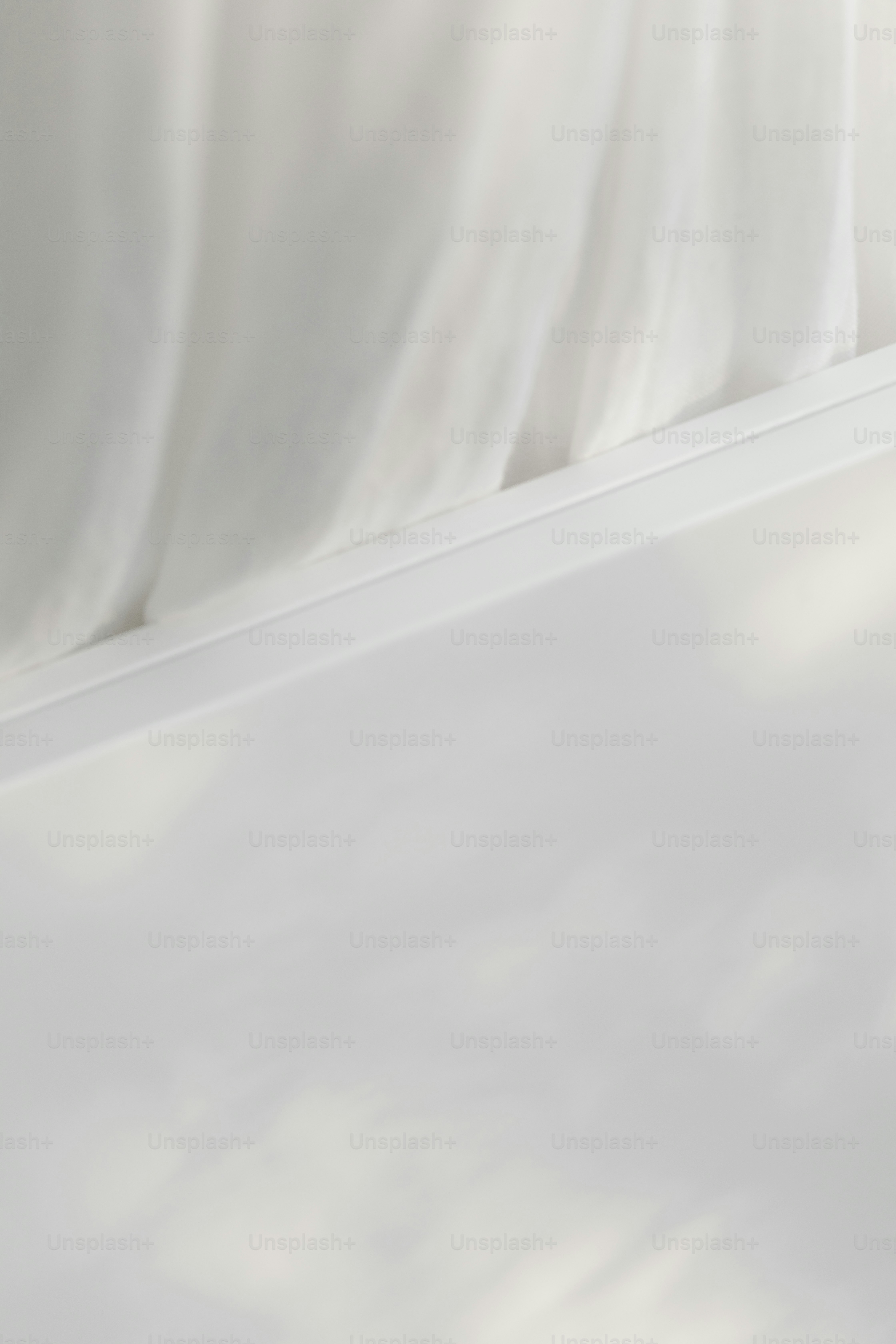 A bed with white sheets and a white headboard photo – Wedding ...