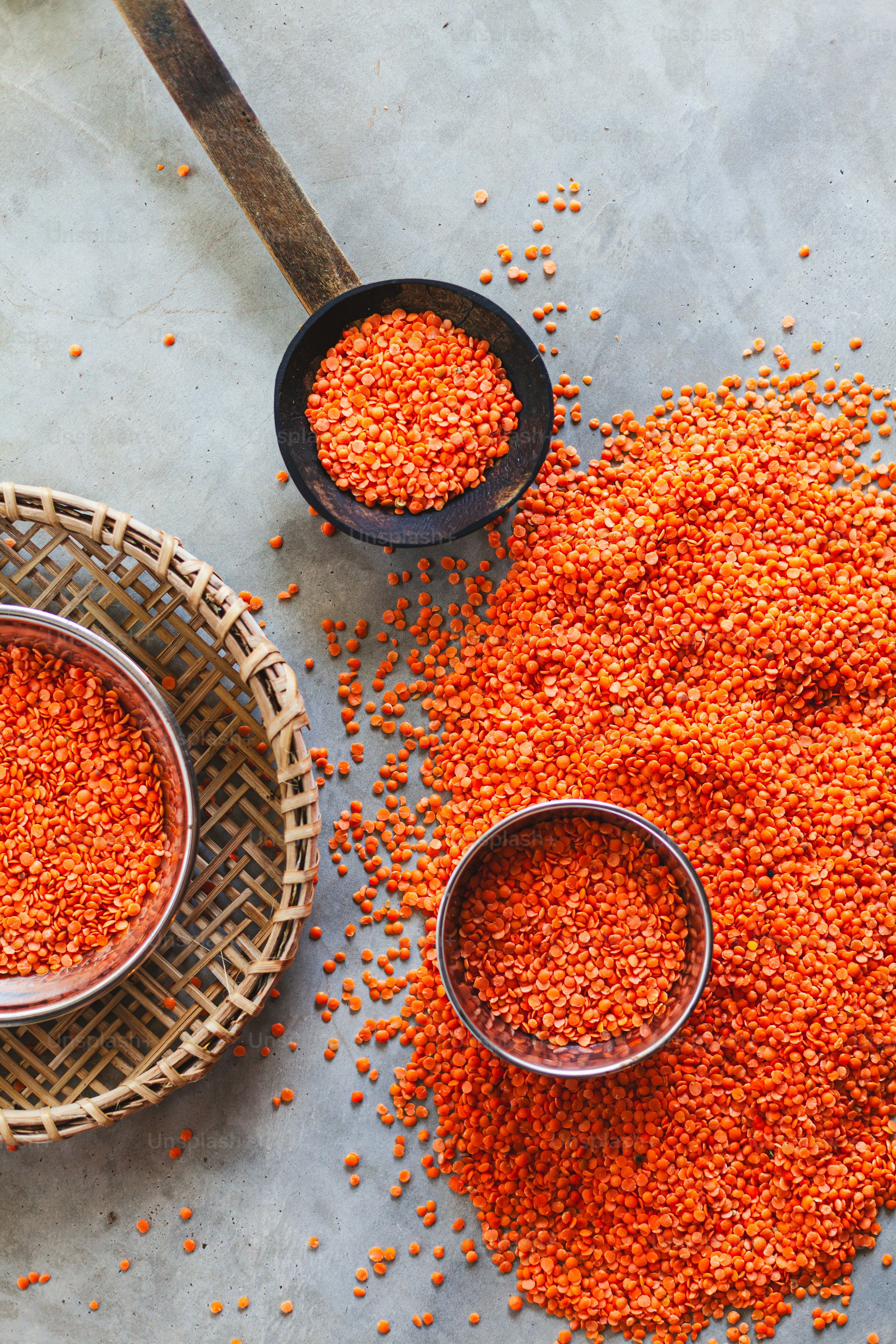 A table topped with two bowls filled with red lentils photo – Lentils ...
