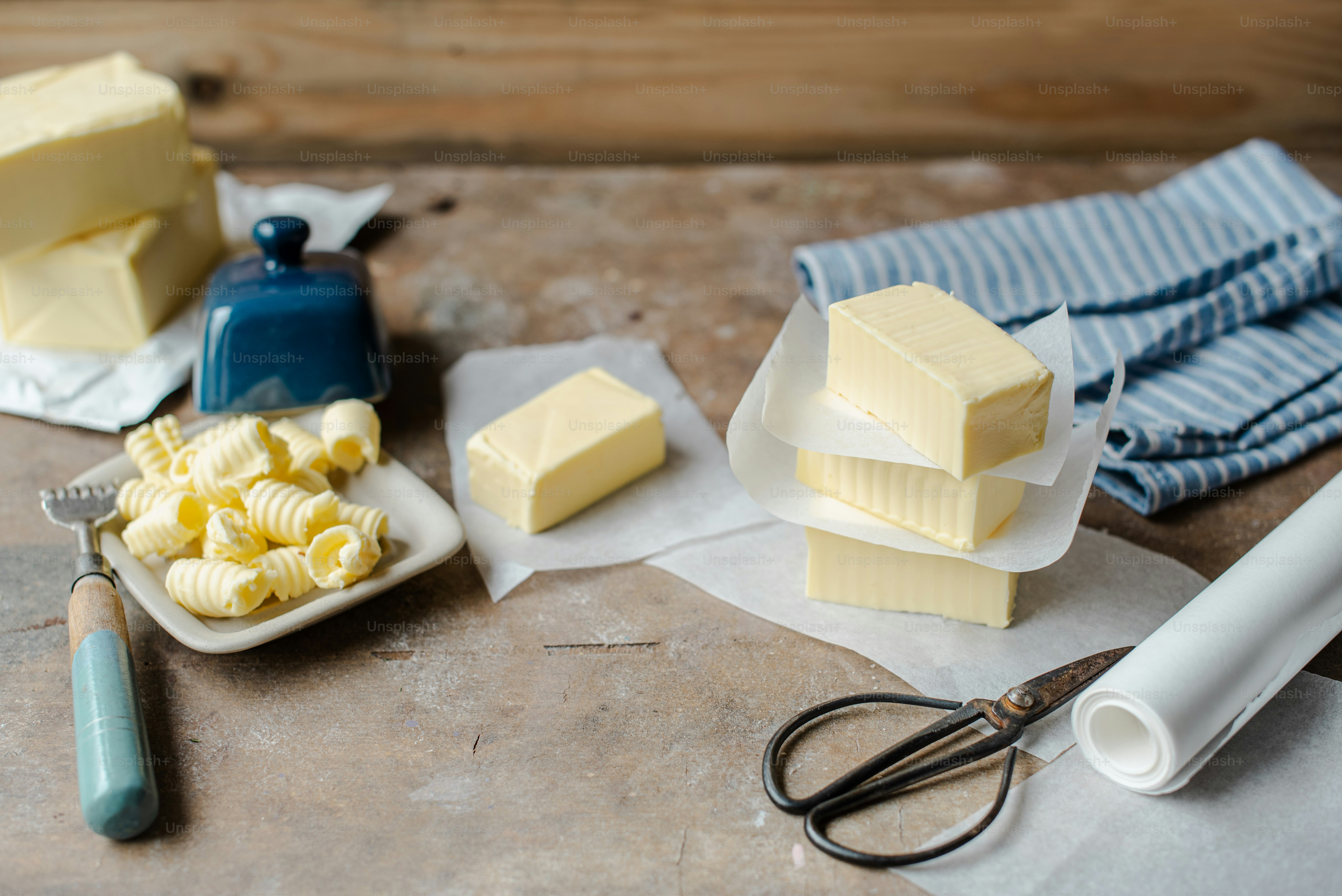 A couple of pieces of butter sitting on top of a table photo – Food ...