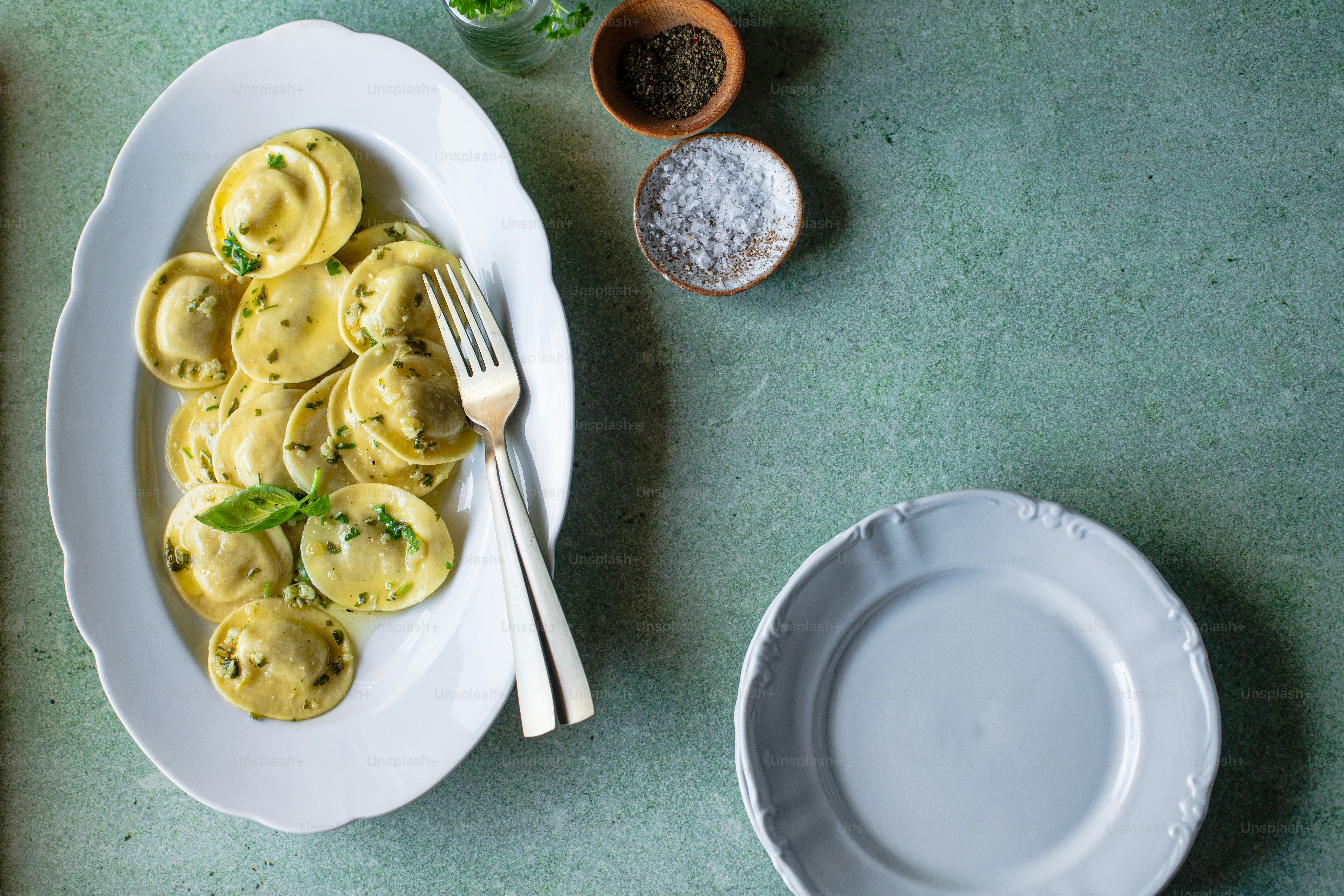A plate of ravioli with a fork on a table photo – Food Image on Unsplash