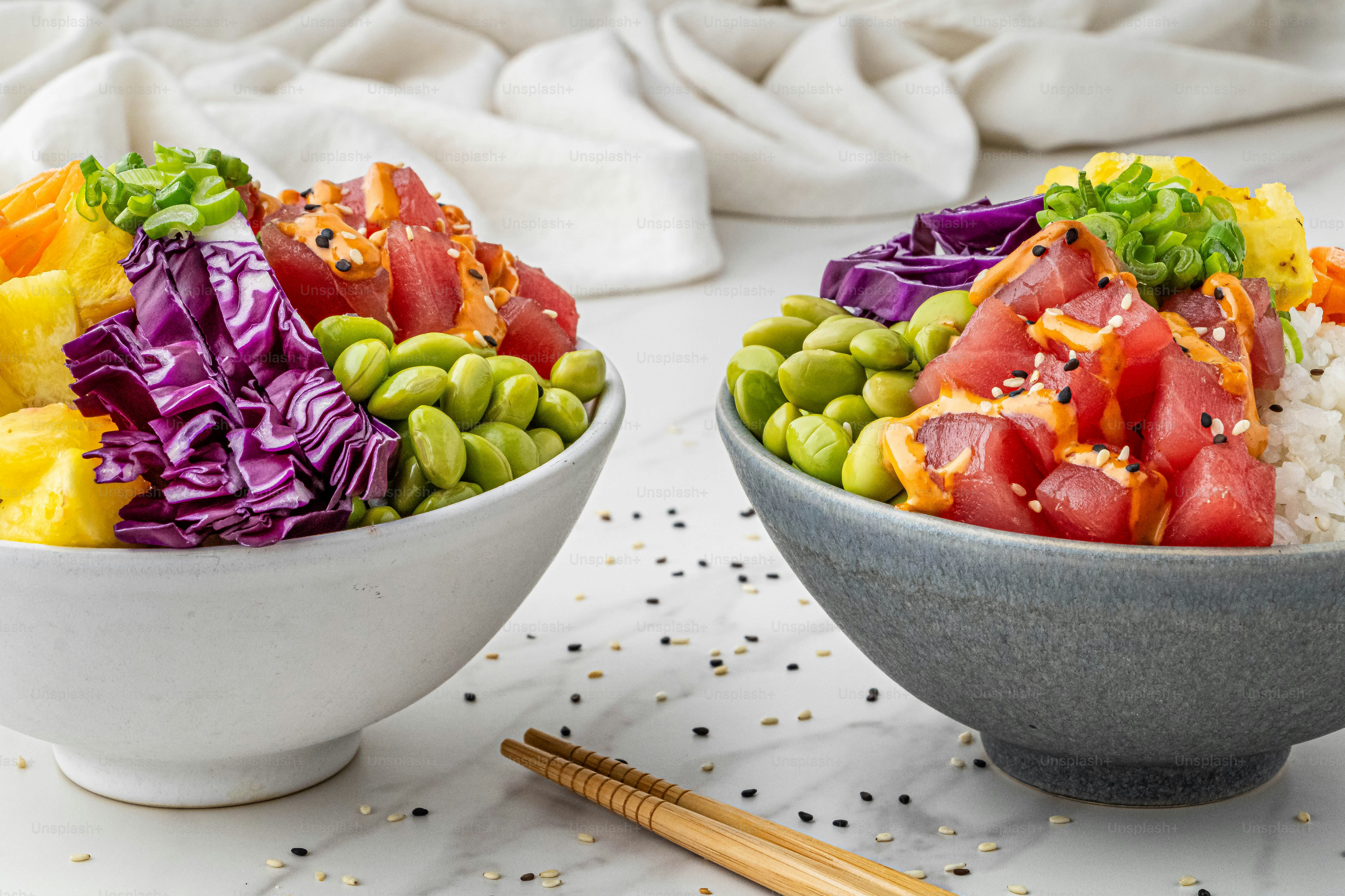 A couple of bowls filled with different types of food photo – Poke ...
