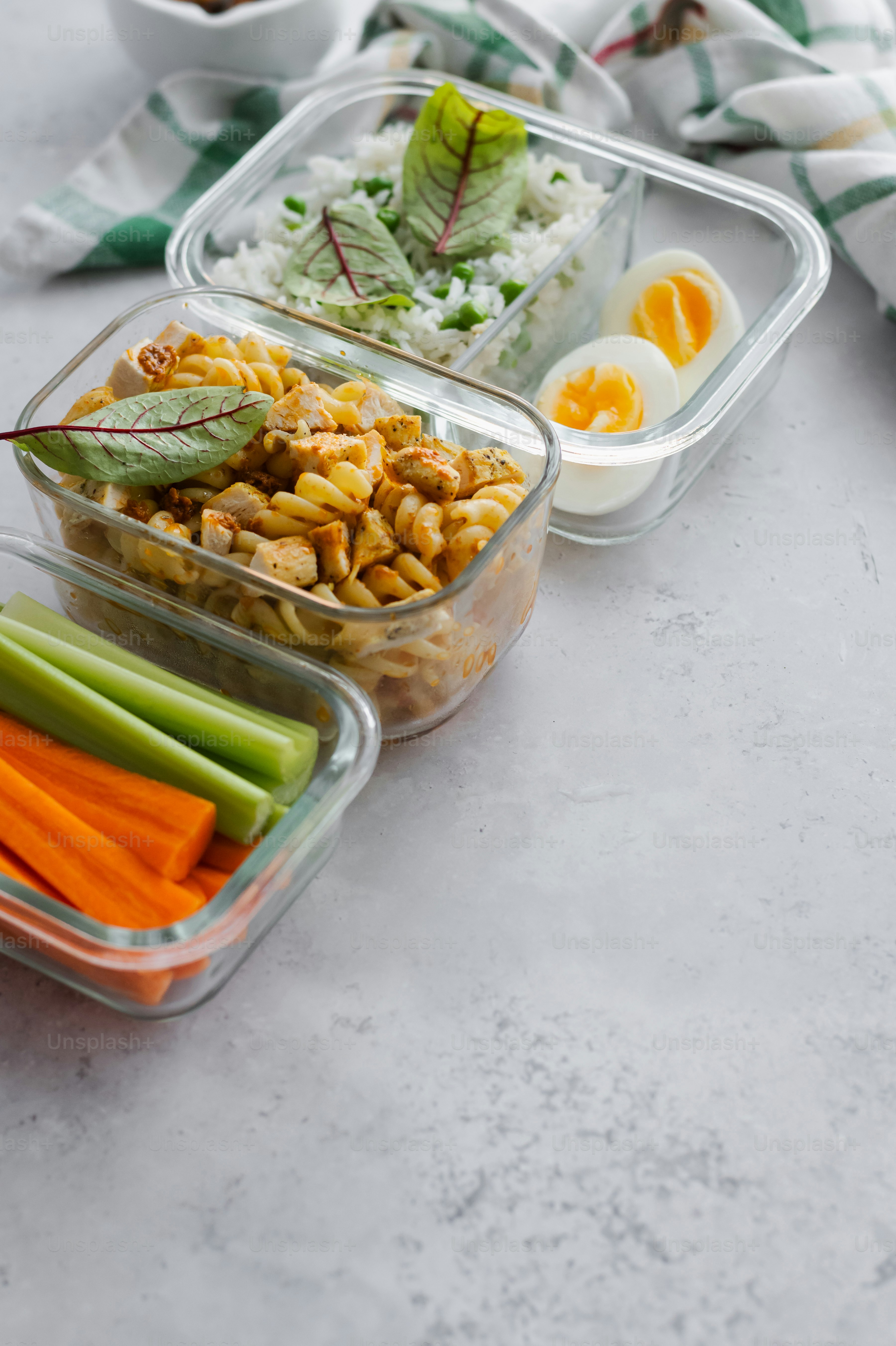 A table topped with plastic containers filled with food photo ...