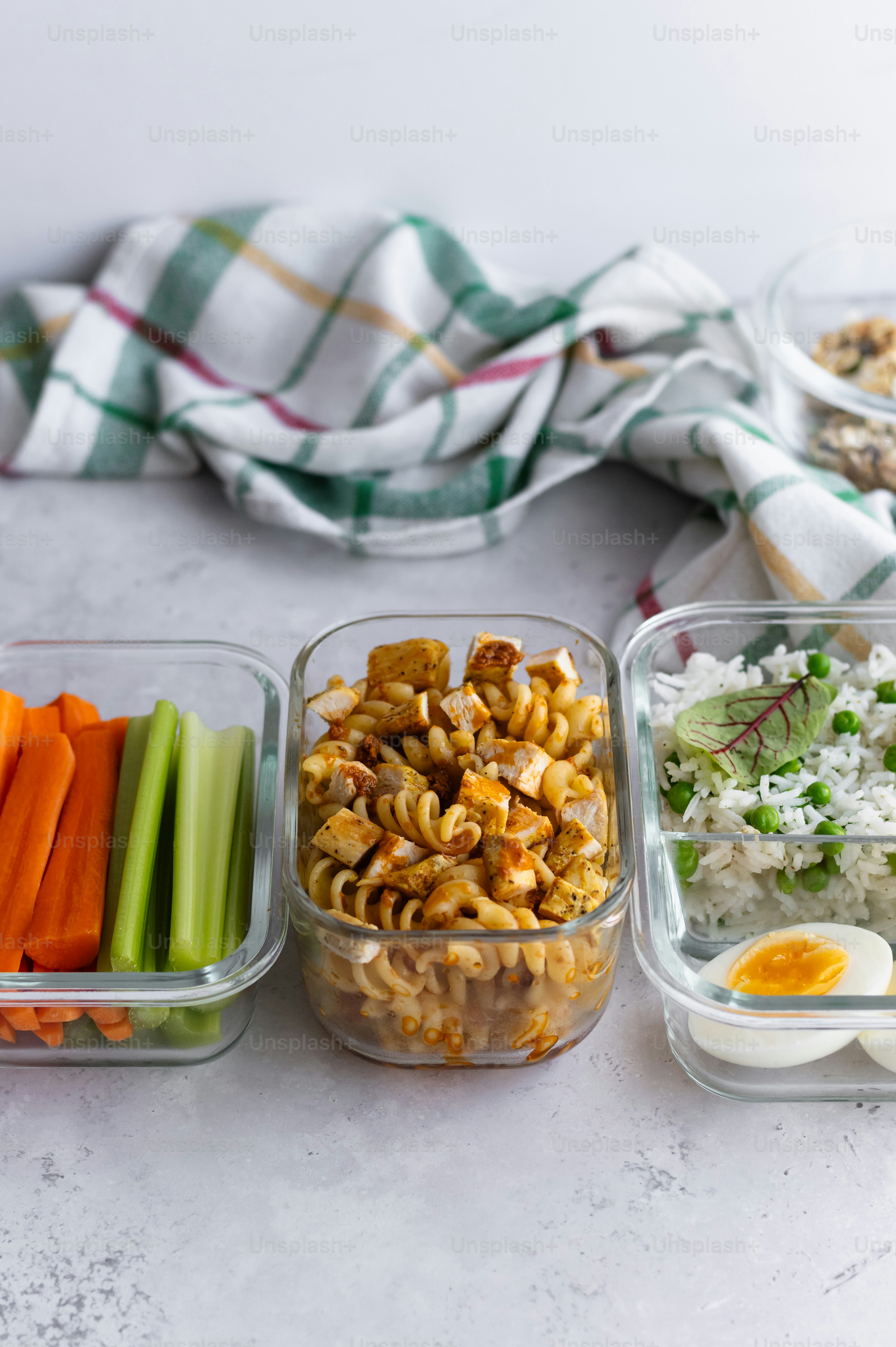 A table topped with plastic containers filled with food photo ...