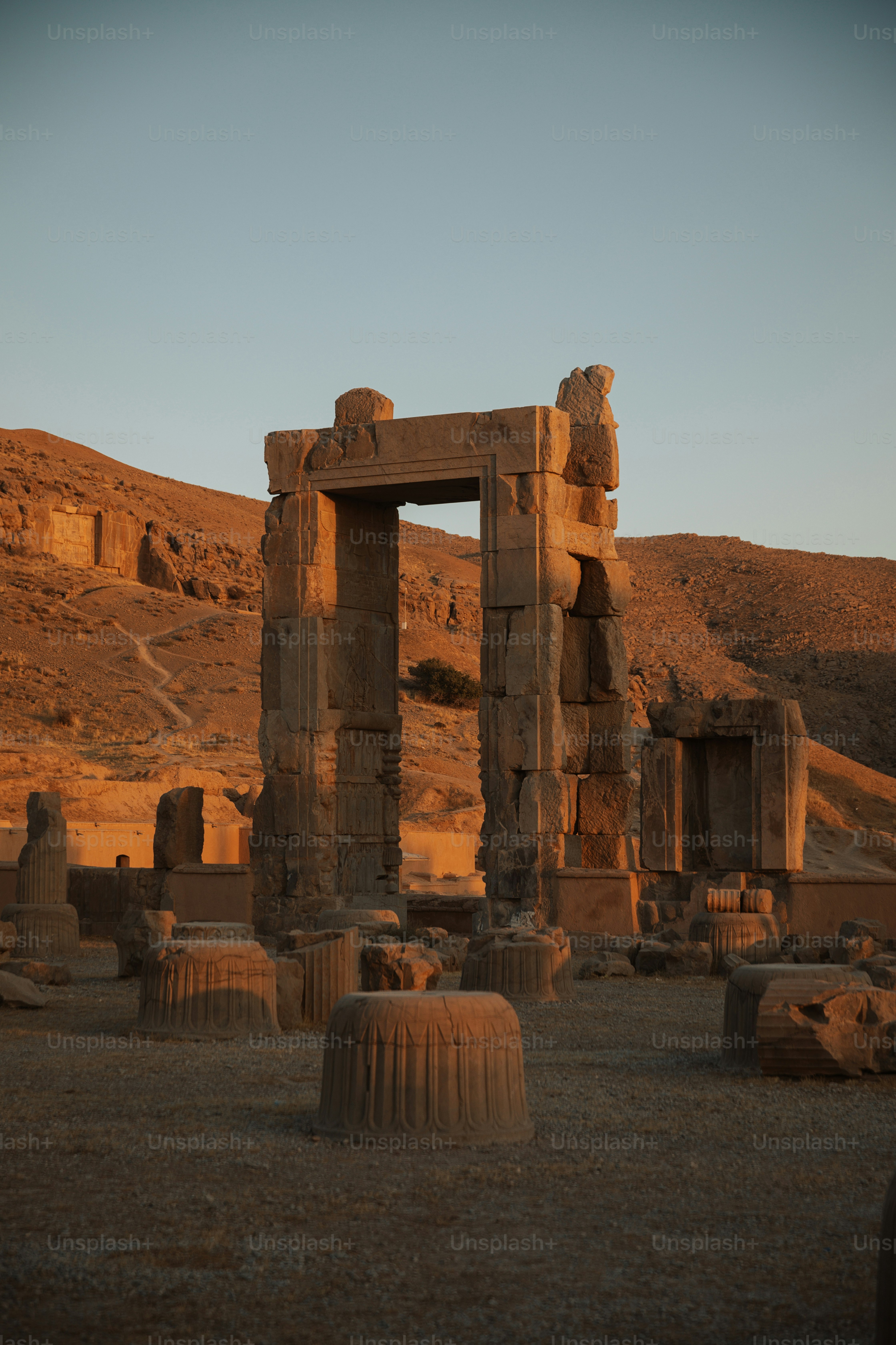 A group of stone pillars sitting in the middle of a desert photo ...