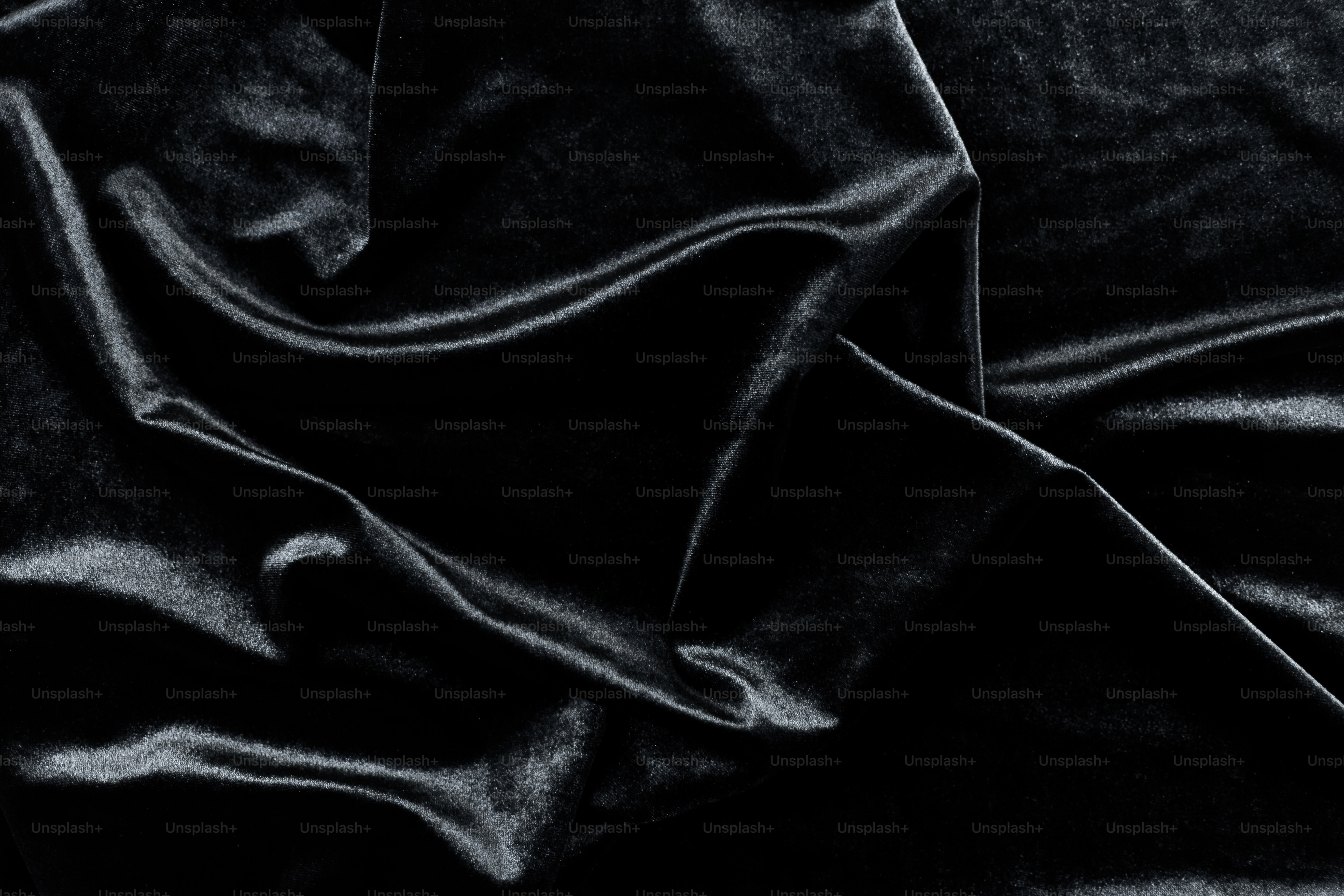 A close up of a black velvet fabric photo – Wallpaper Image on Unsplash
