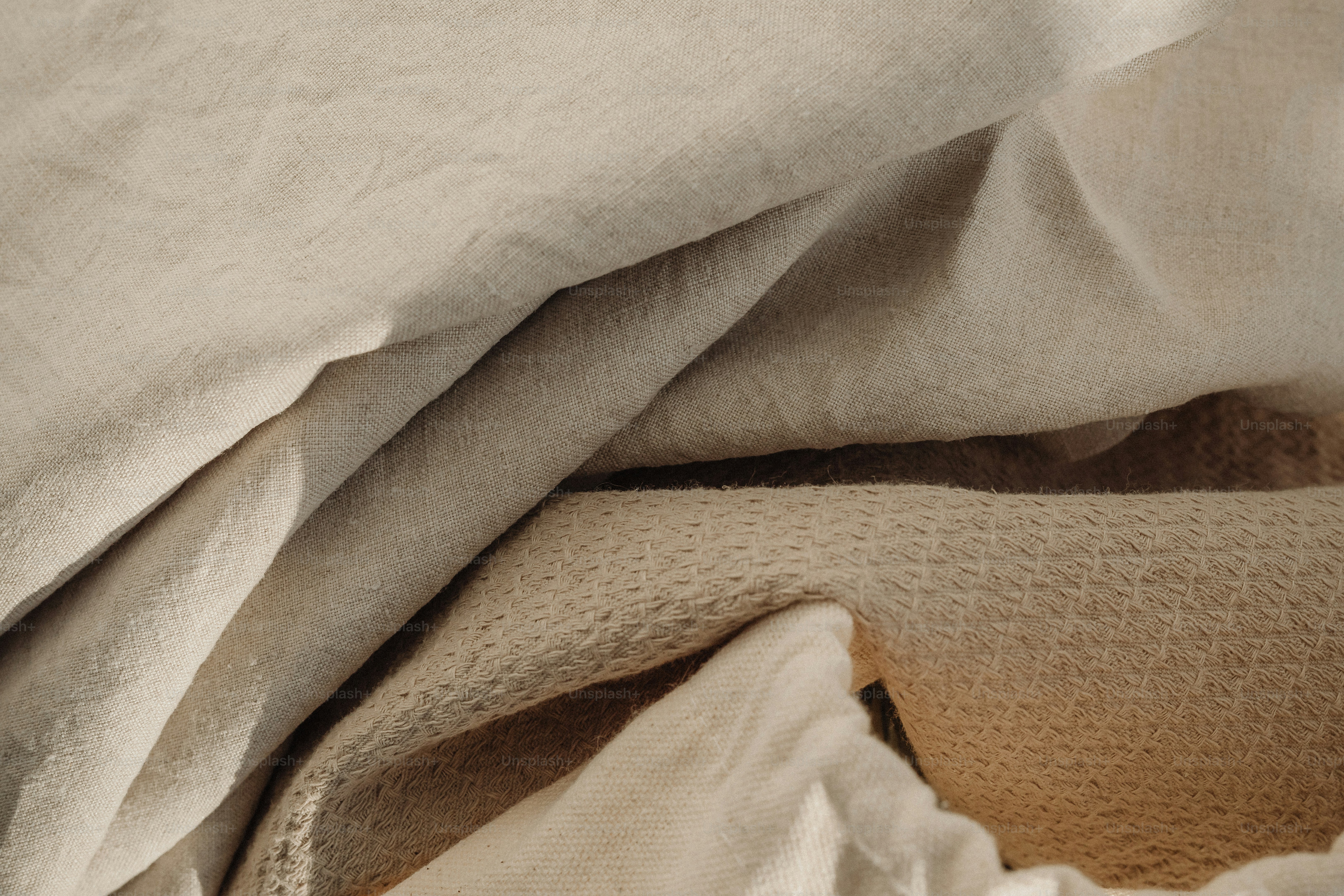 A close up of a bed with a white comforter photo – Wedding background ...