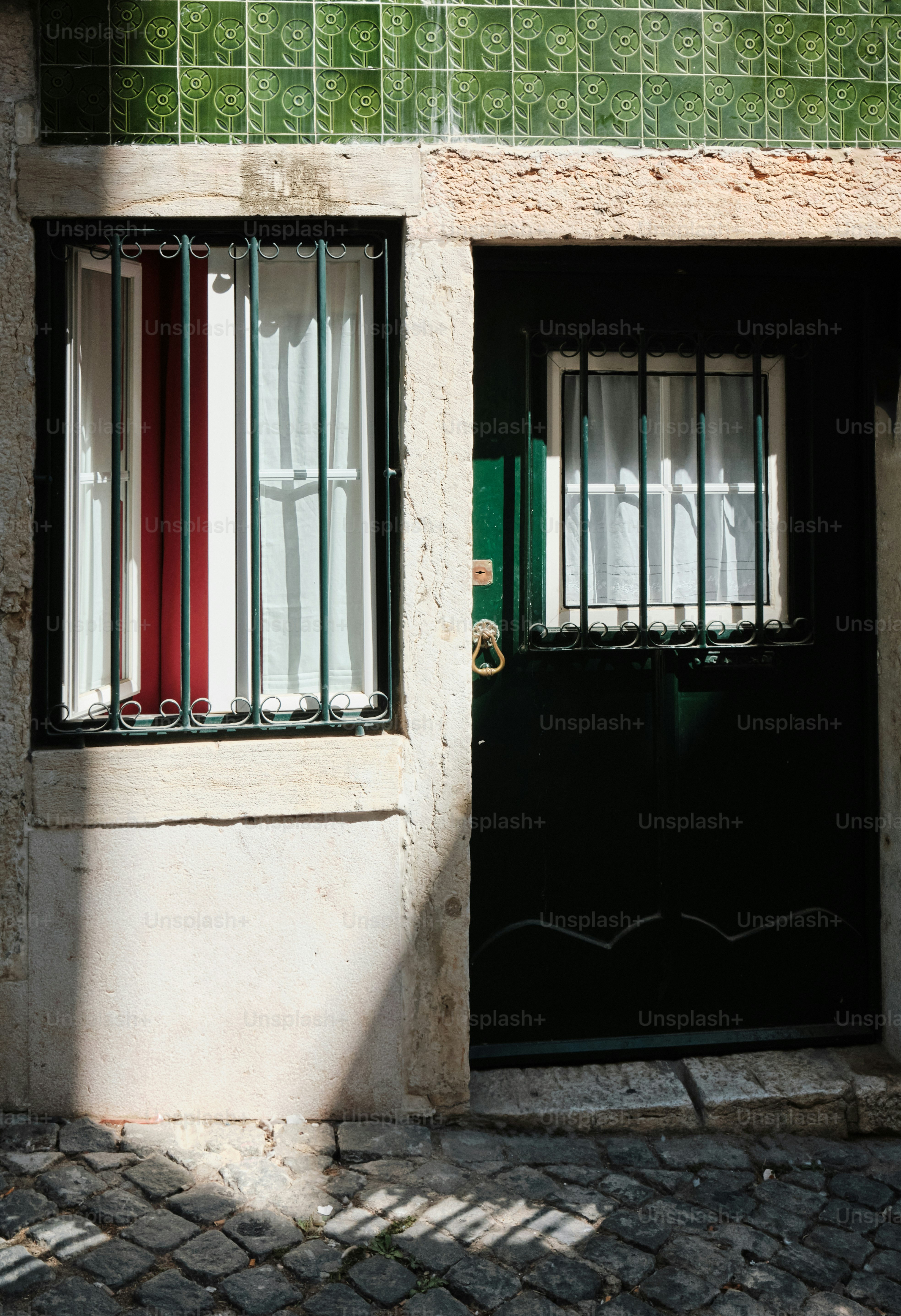 A building with two doors and a window photo – Street photography Image ...