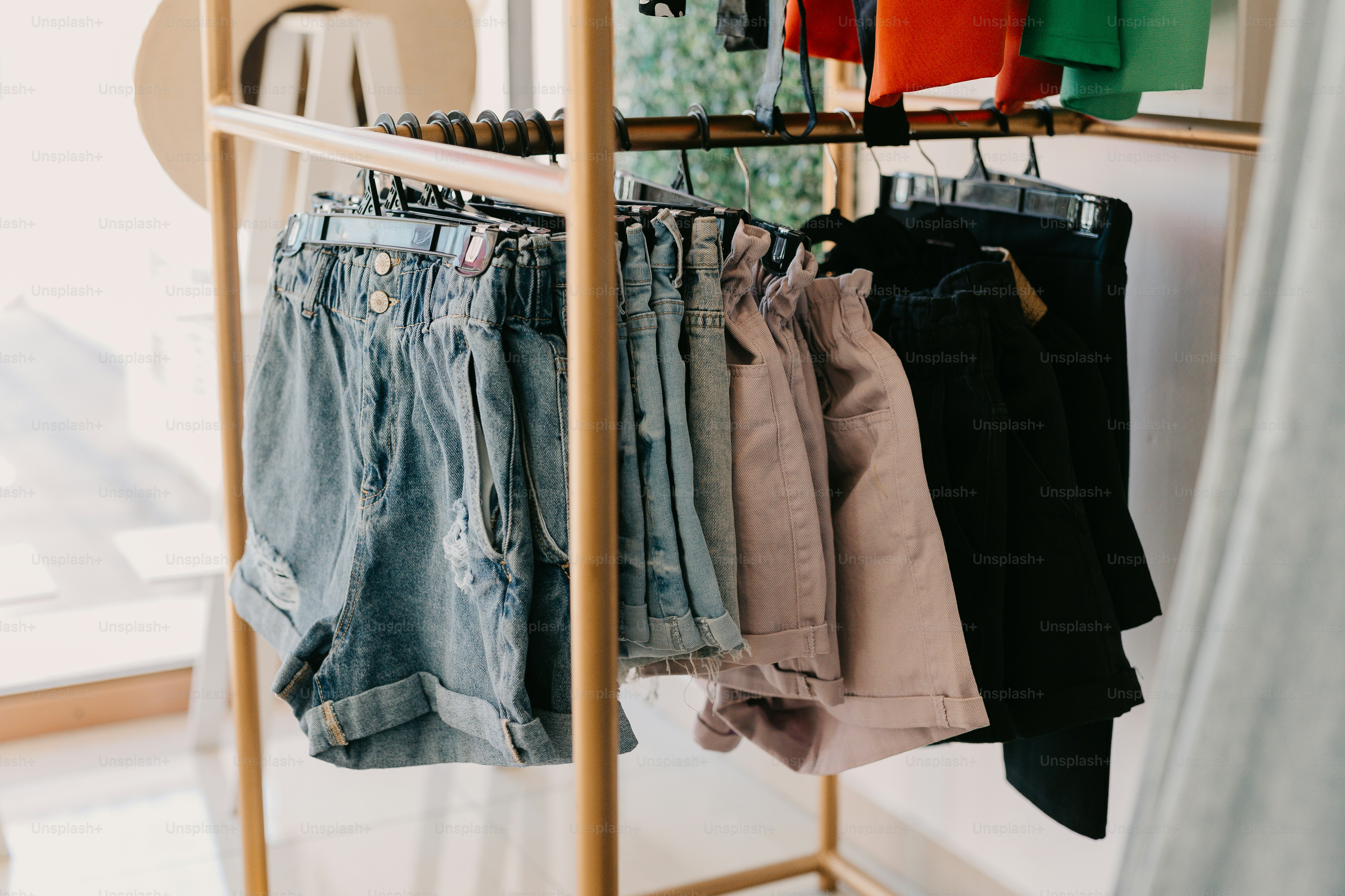 A rack of jeans hanging on a clothes rack photo – Shopping Image on ...