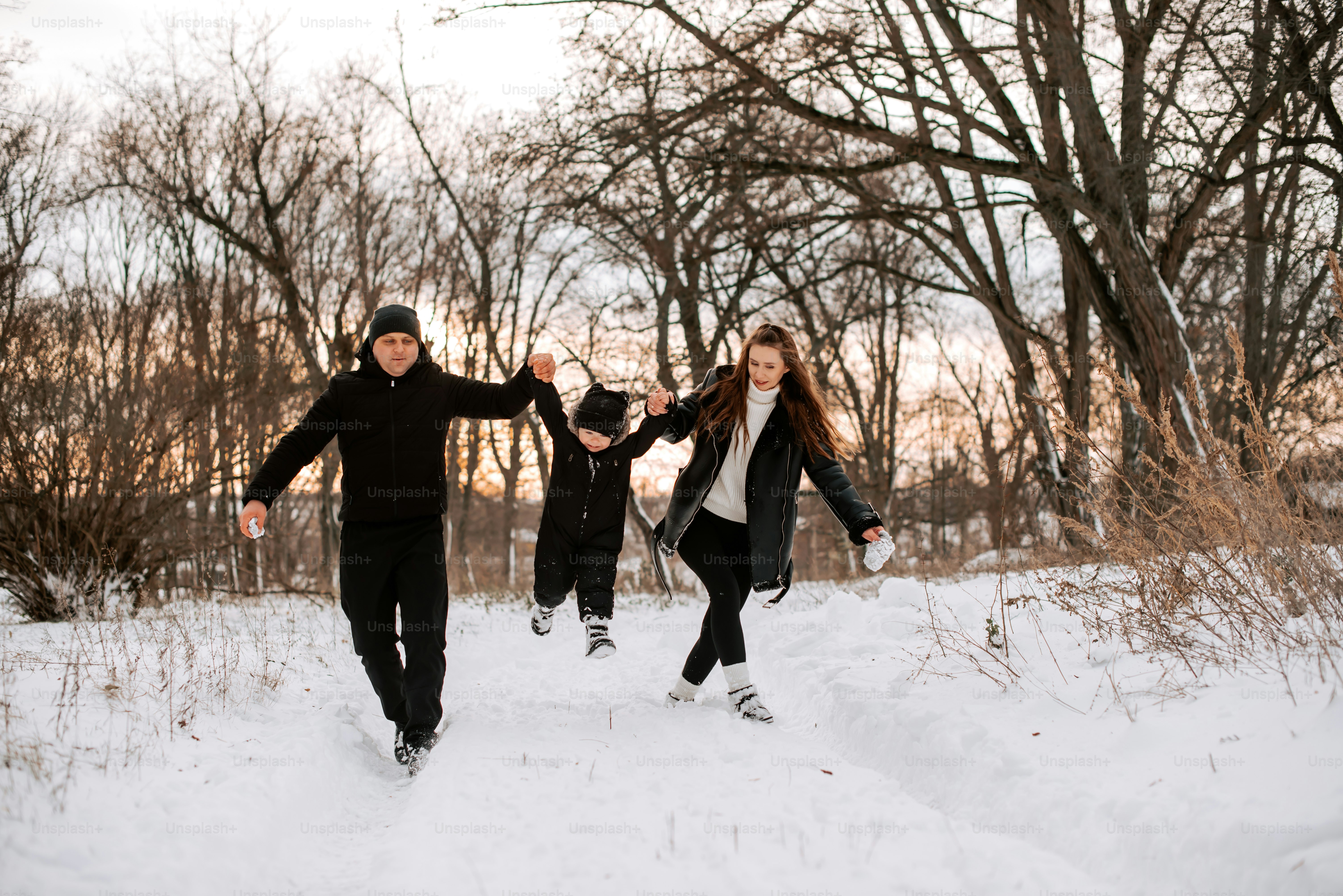 A couple of people that are walking in the snow photo – Family Image on ...