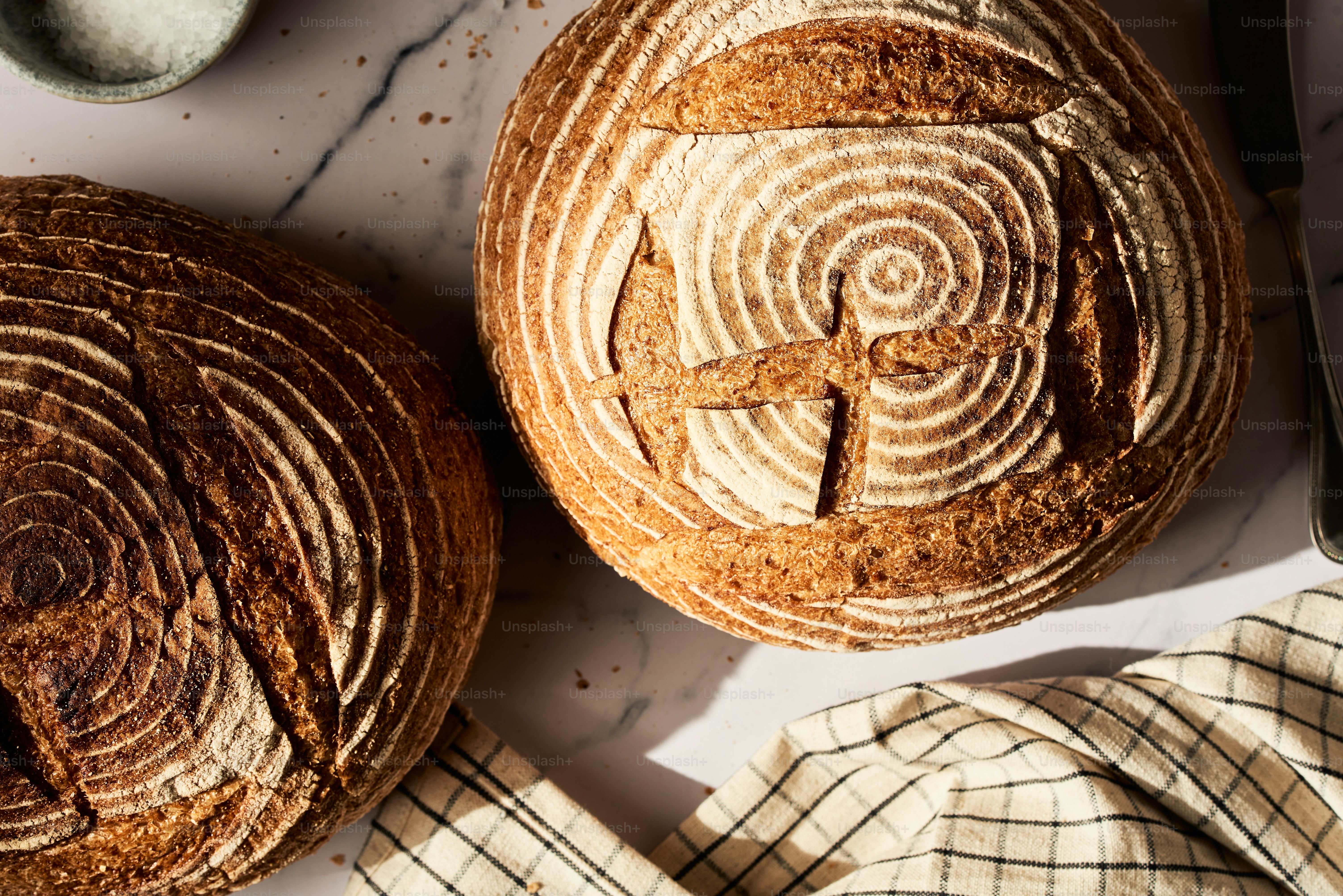 Two loaves of bread sitting on top of a table photo – Food Image on ...