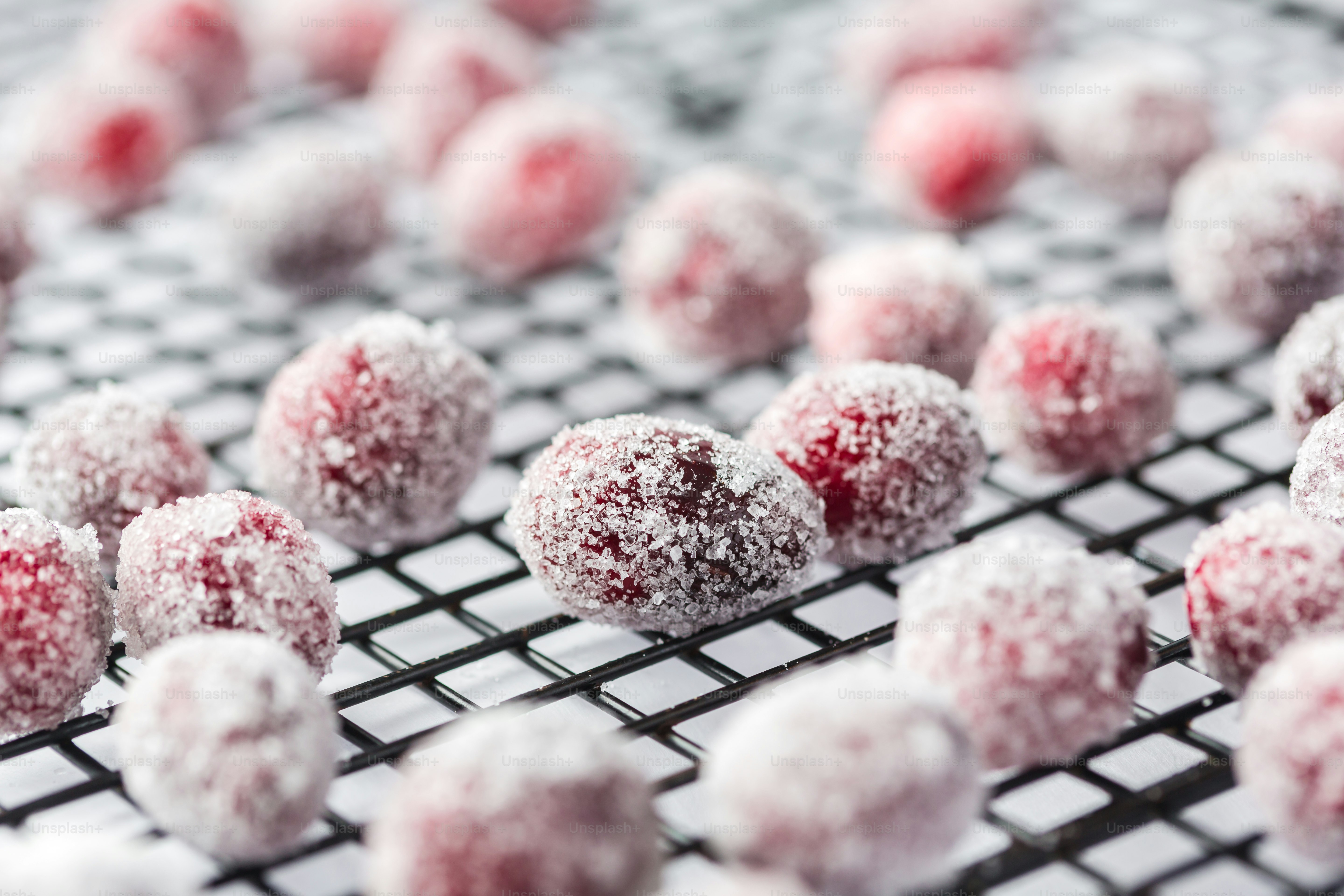 A bunch of powdered sugar balls sitting on a cooling rack photo ...