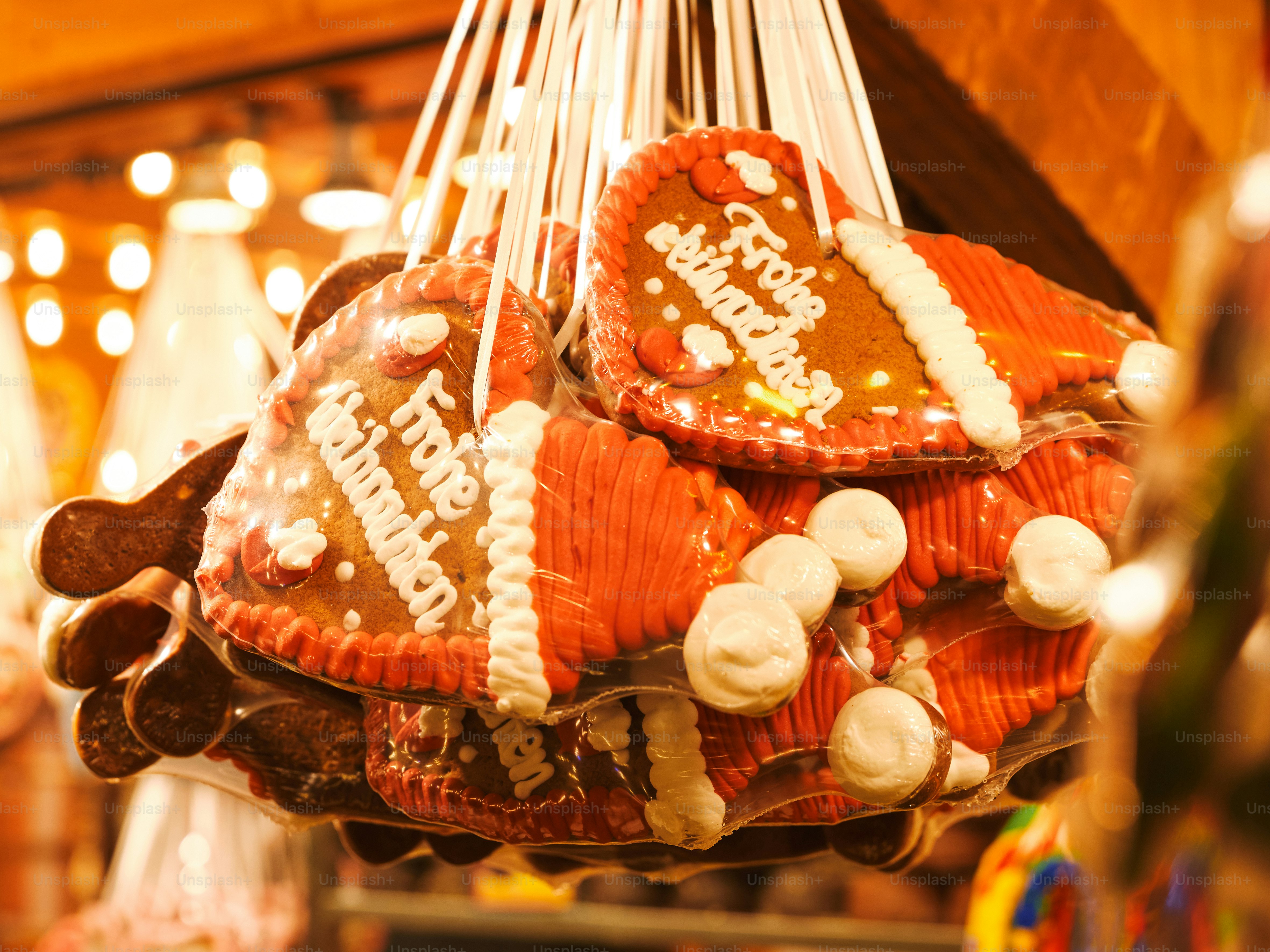 A couple of heart shaped cookies hanging from a string photo ...