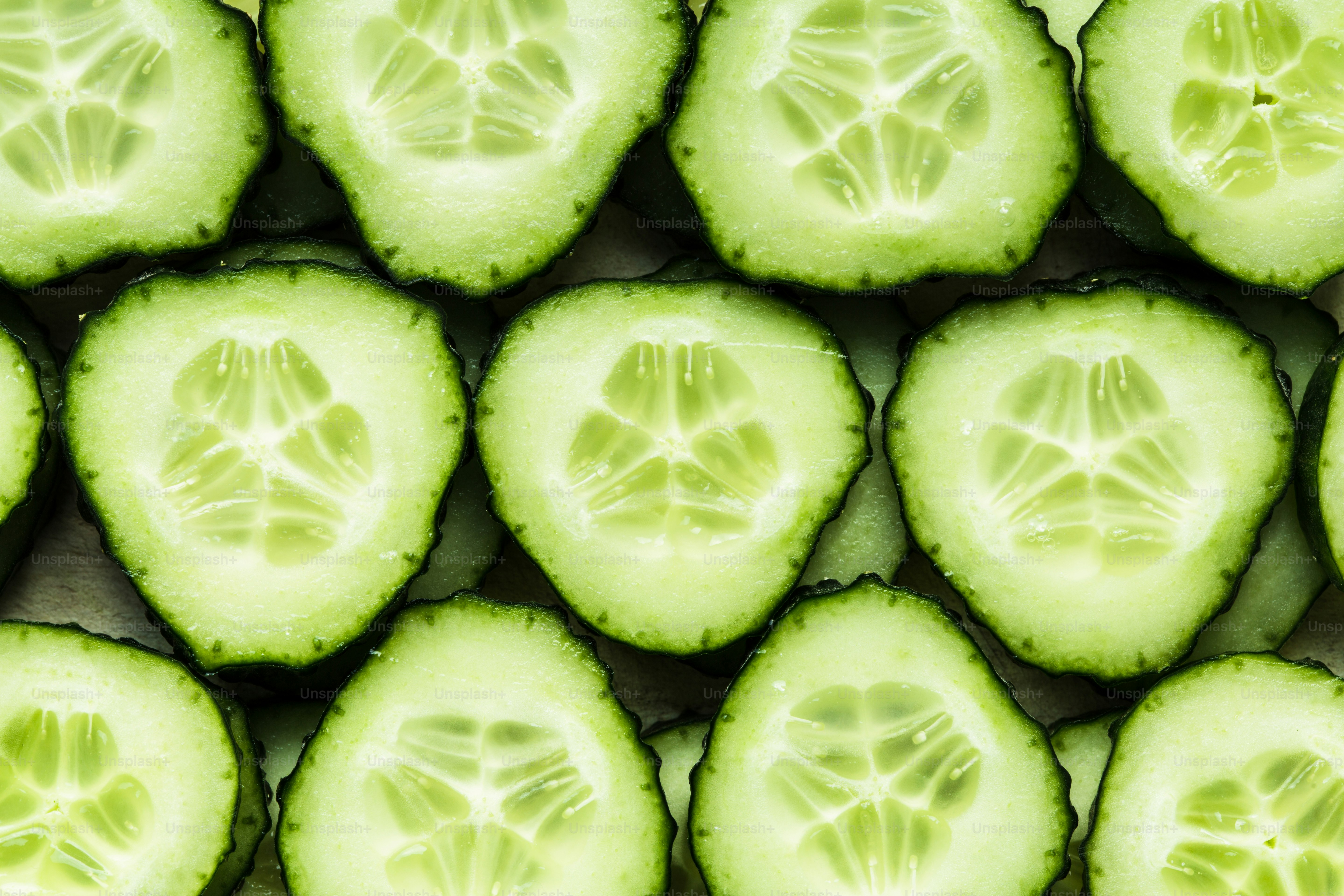 A bunch of cucumbers that are cut in half photo – Cucamber Image on ...