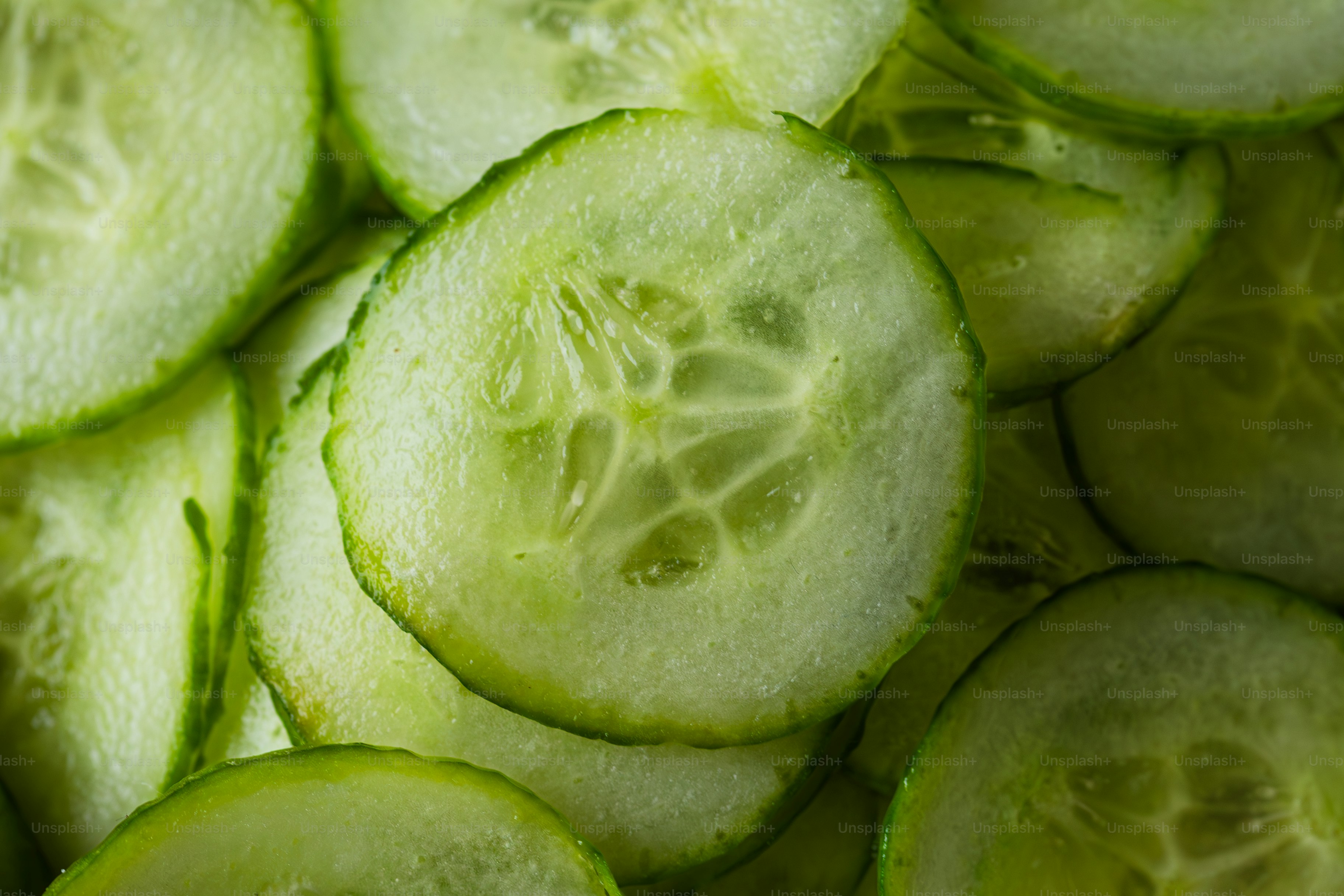 A pile of sliced cucumbers sitting on top of a table photo – Cucumber ...