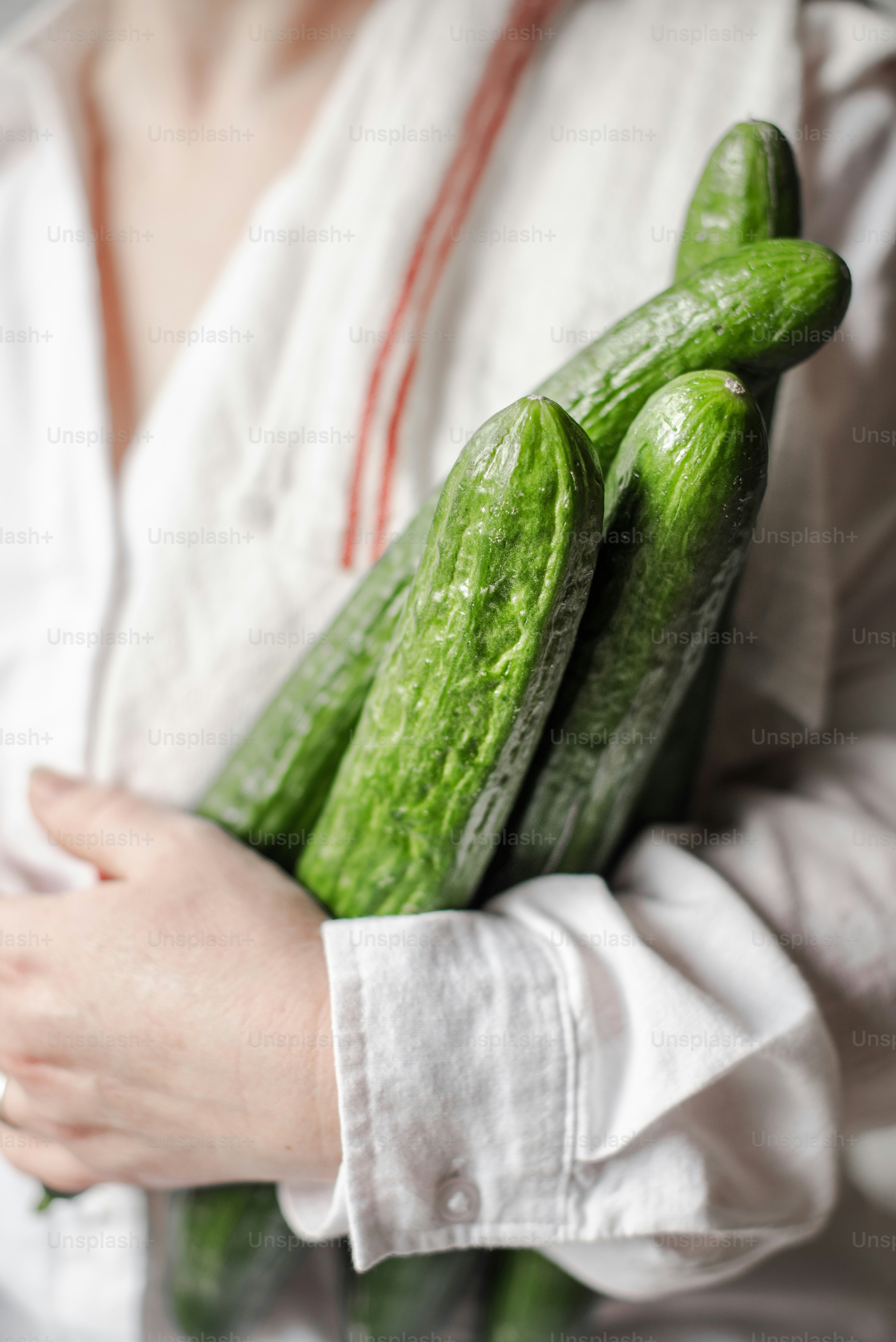 A close up of a person holding a bunch of pickles photo – Healthy food ...