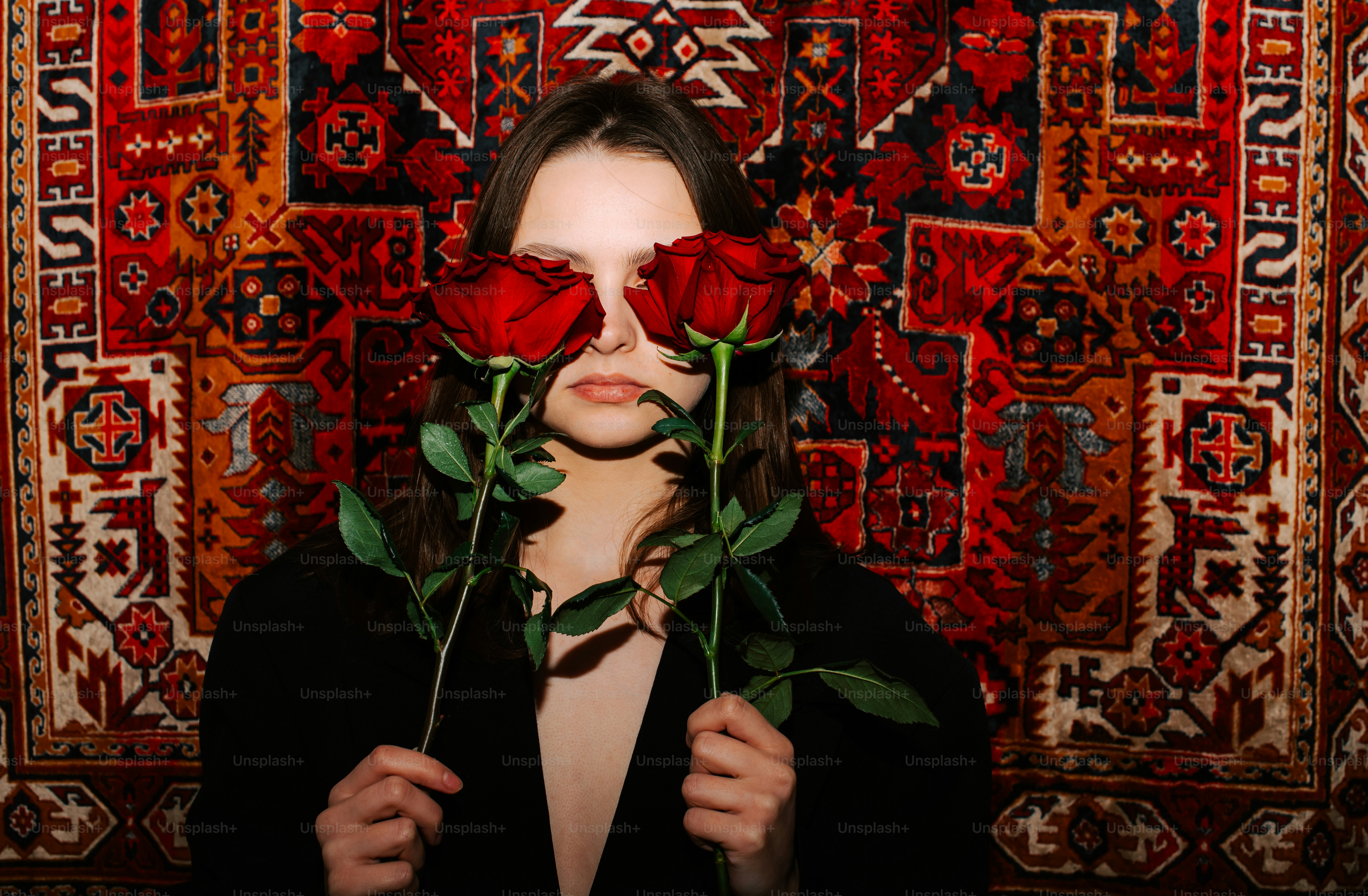 A woman holding two roses in front of her face photo – Valentines day ...