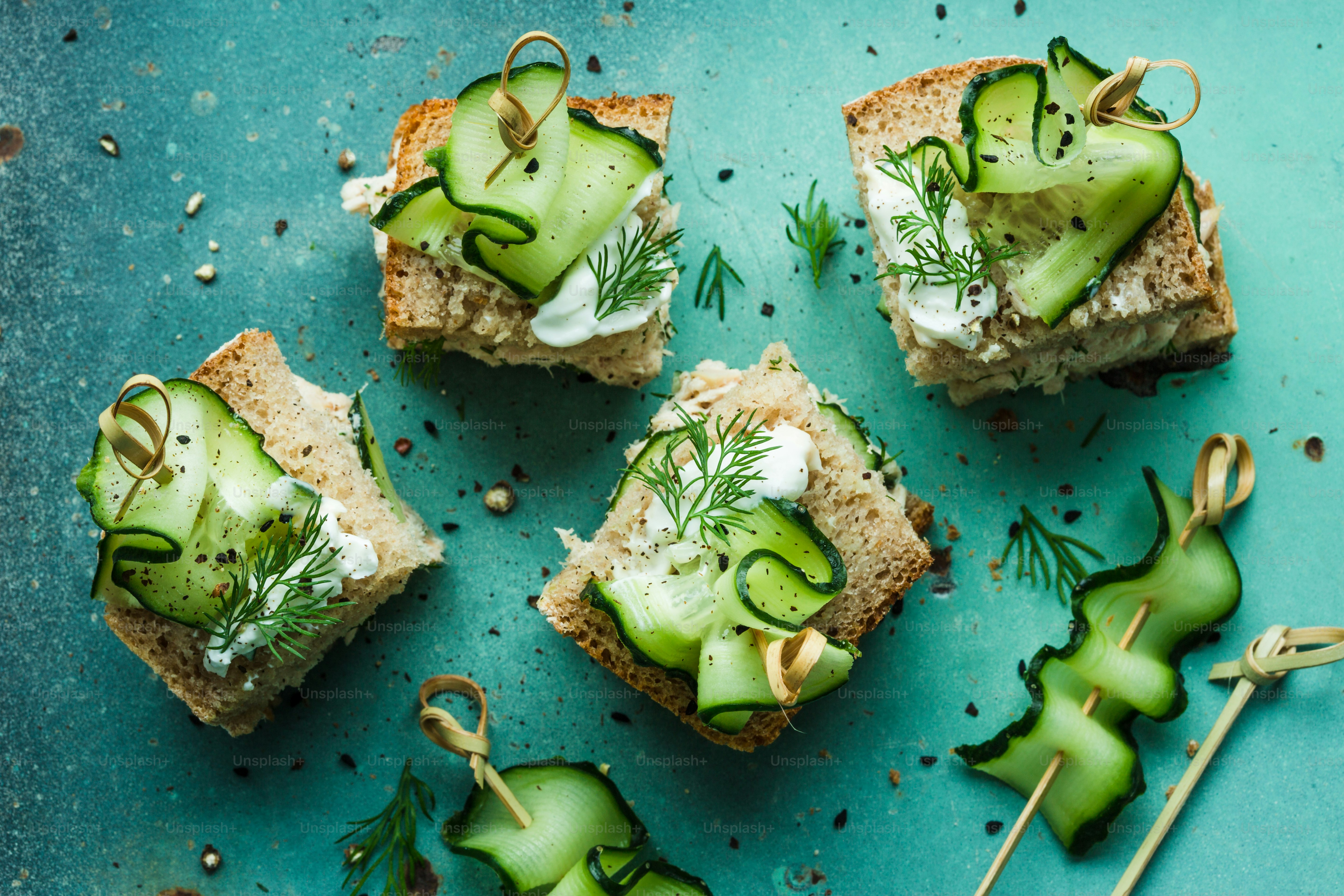 Four pieces of bread with cucumbers on them photo – Sandwich Image on ...