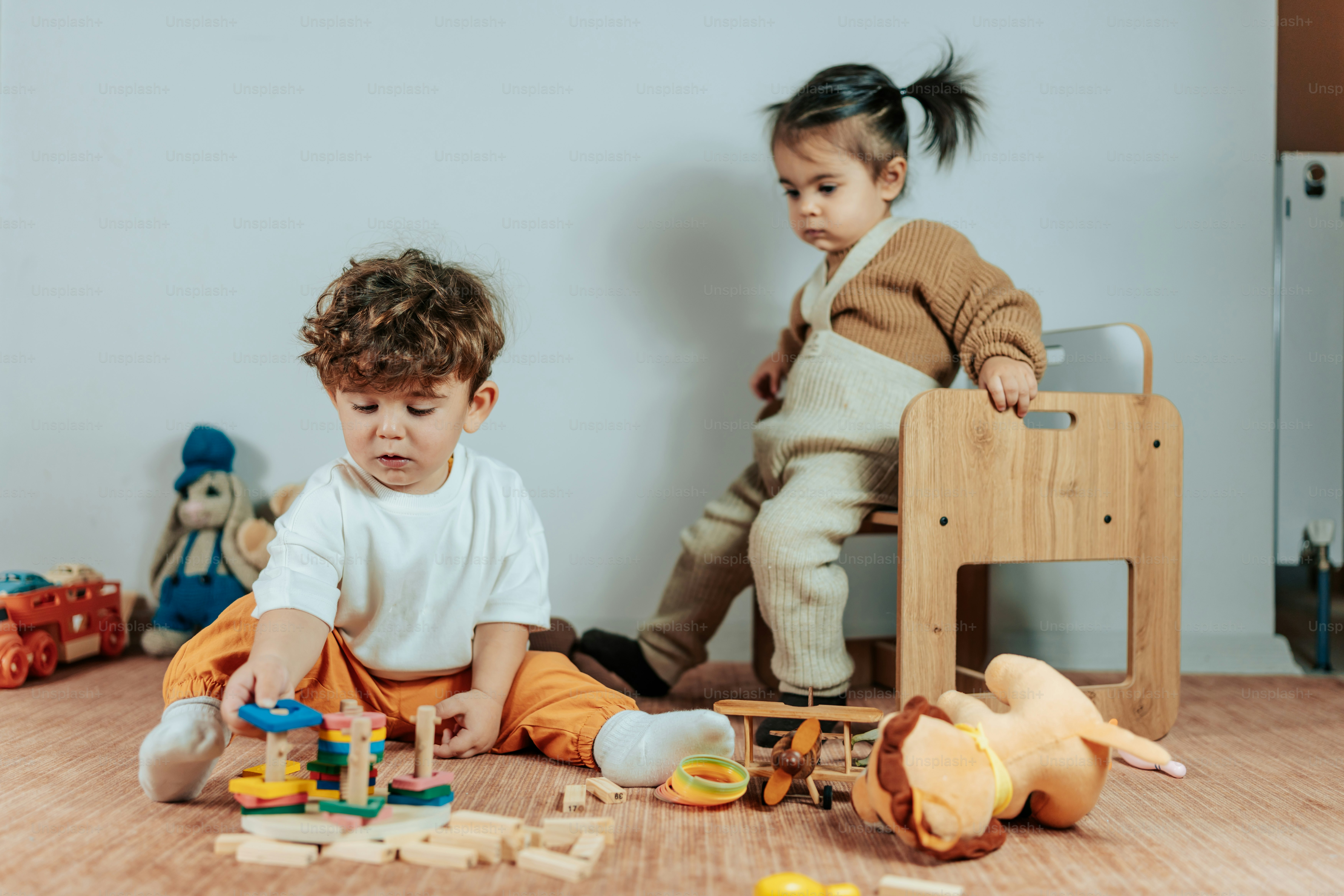 A young child playing with toys on the floor photo – Kids Image on Unsplash