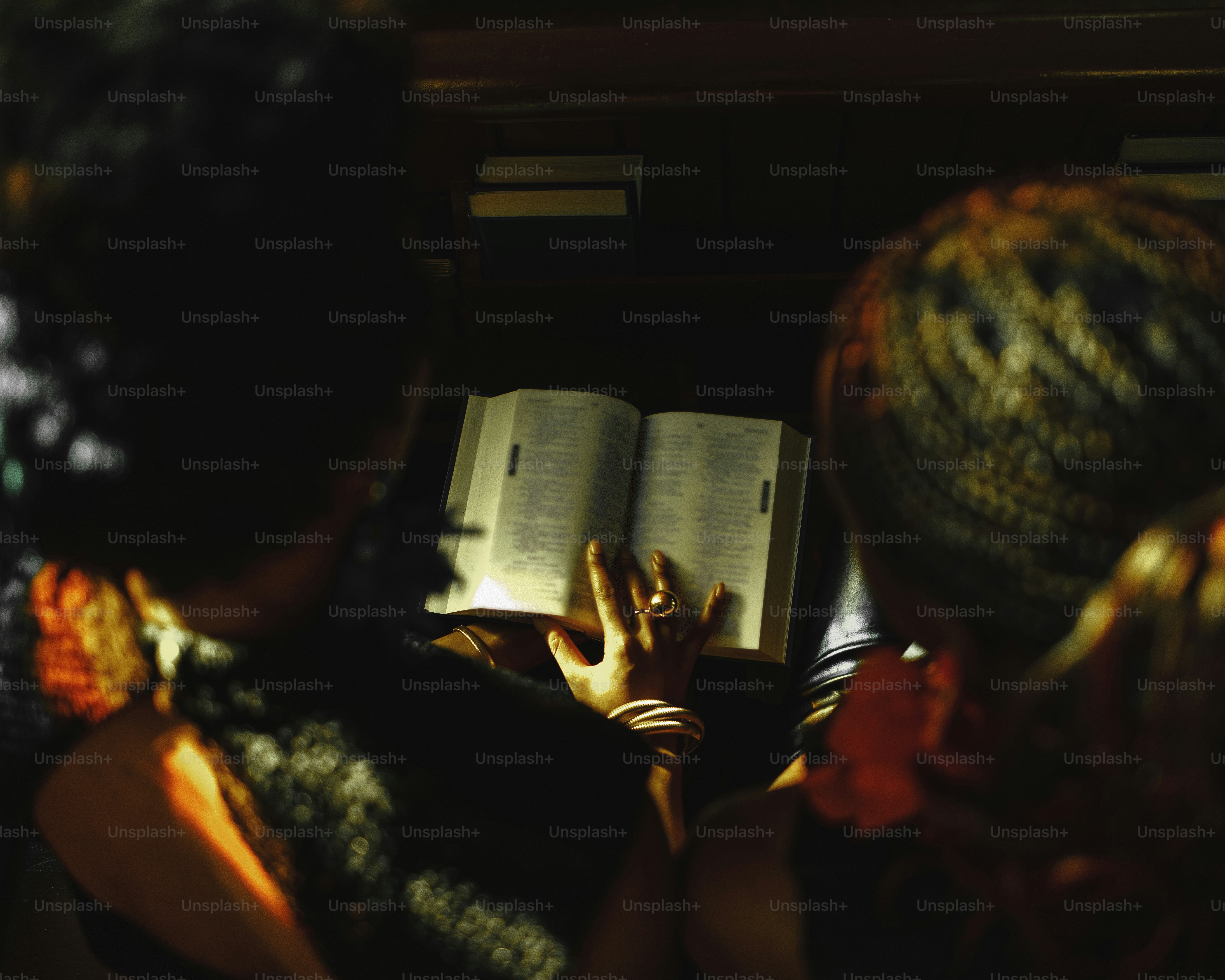 Two women are reading a book together photo – Bible Image on Unsplash