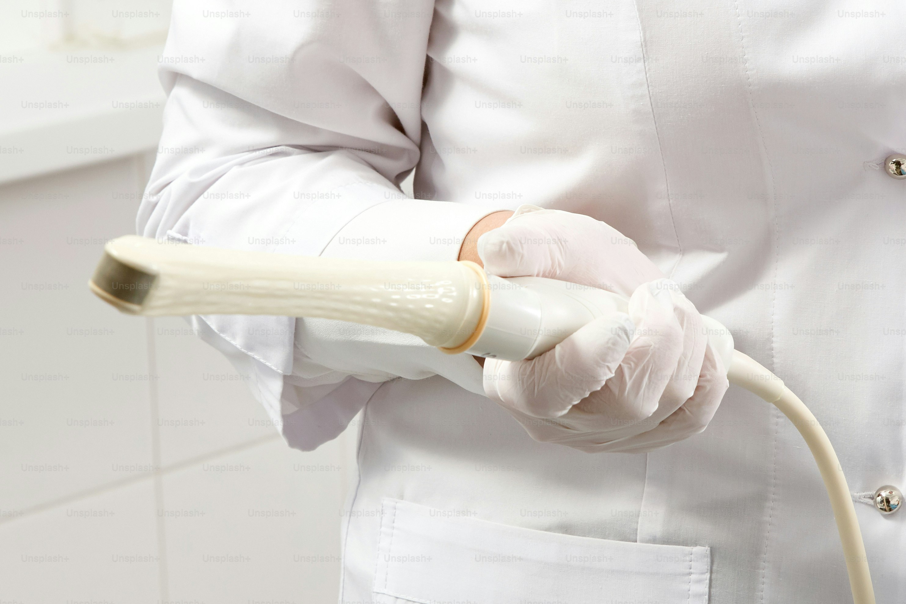 Gynecologist holding transvaginal ultrasound wand to exam woman photo ...