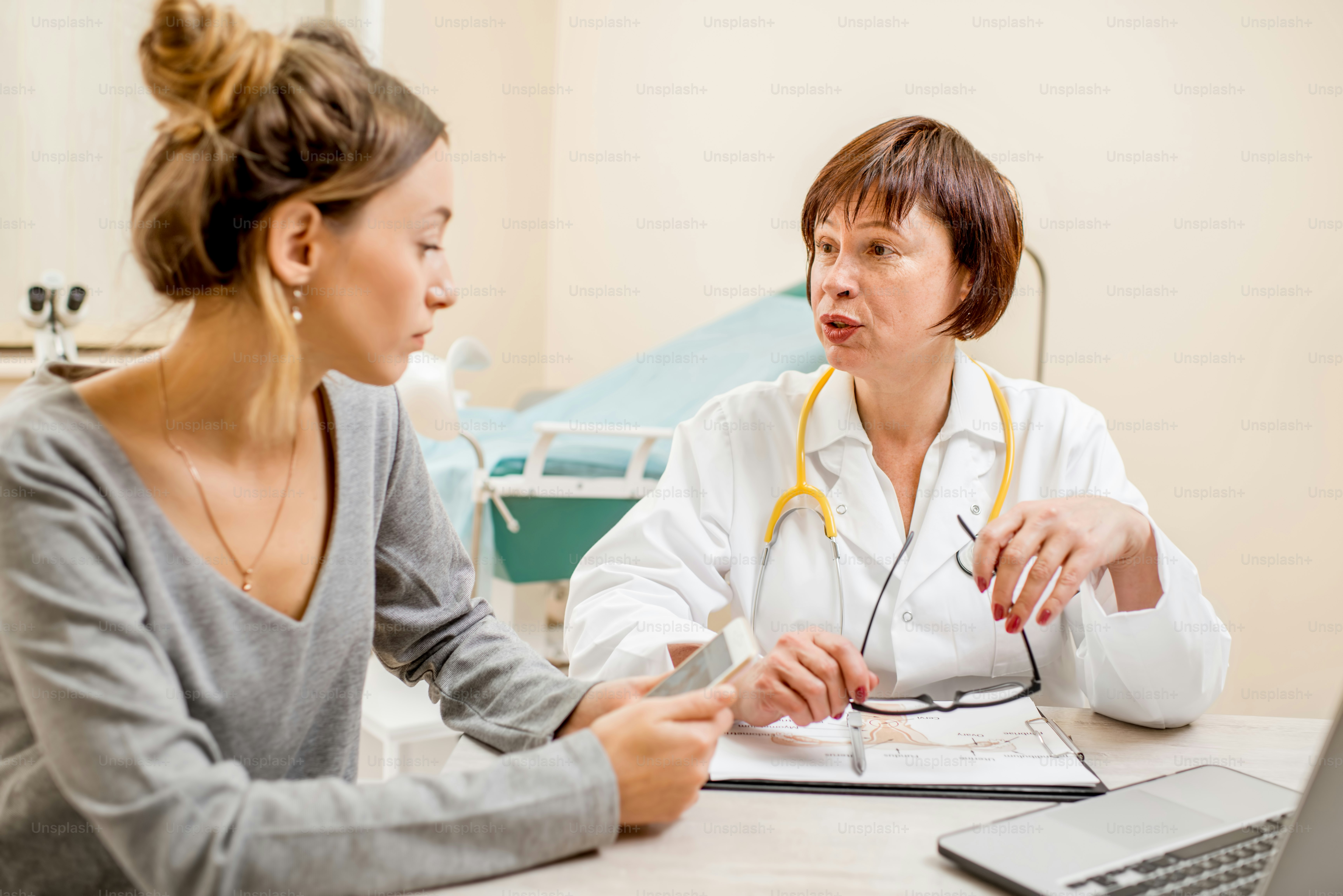 Young woman patient with a senior gynecologist during the consultation ...