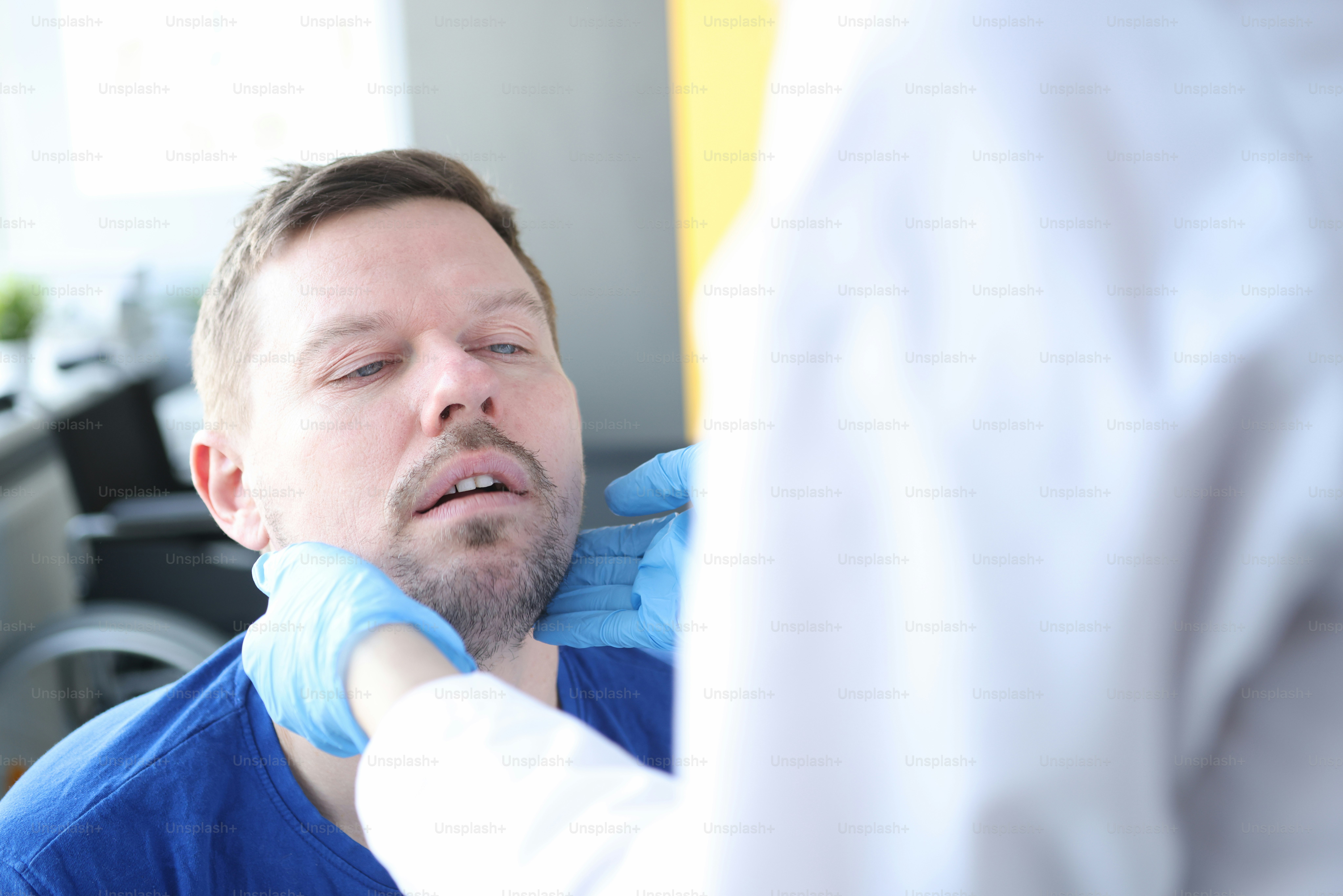 Doctor examines patient's thyroid gland in medical office. Thyroid ...