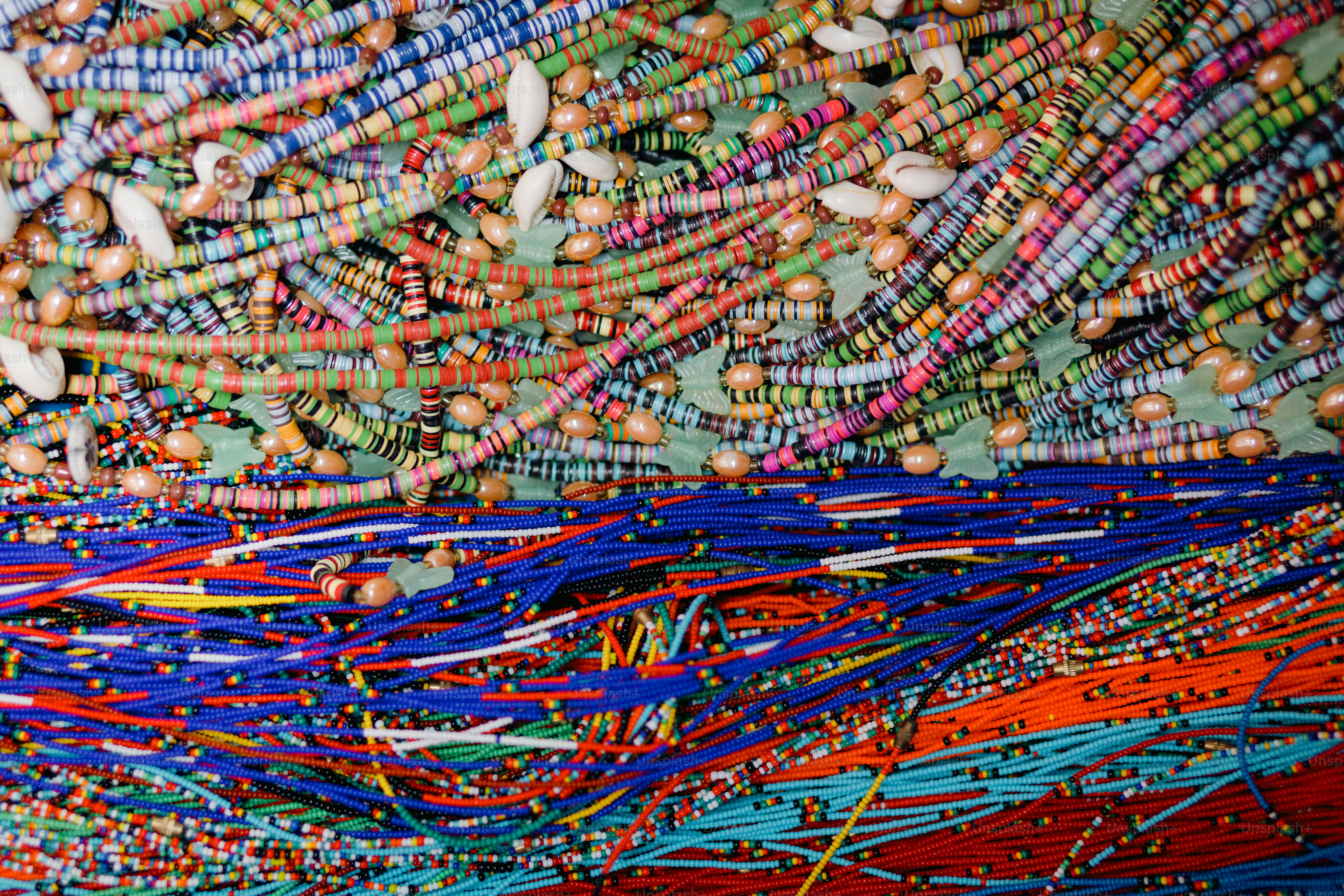 A large pile of colorful beads on a table photo – Beads Image on Unsplash
