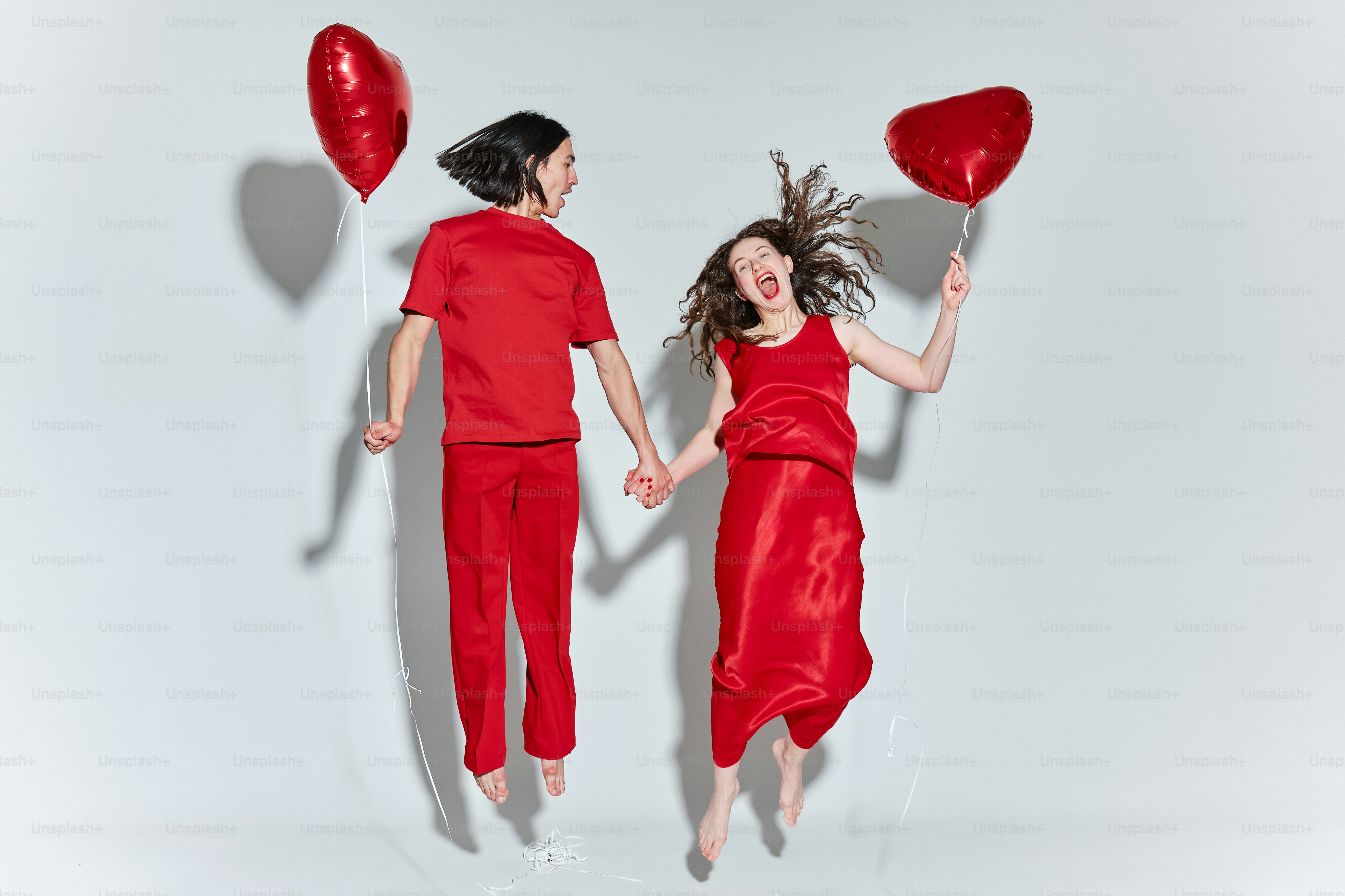 A couple of people that are jumping in the air photo – Valentine Image ...