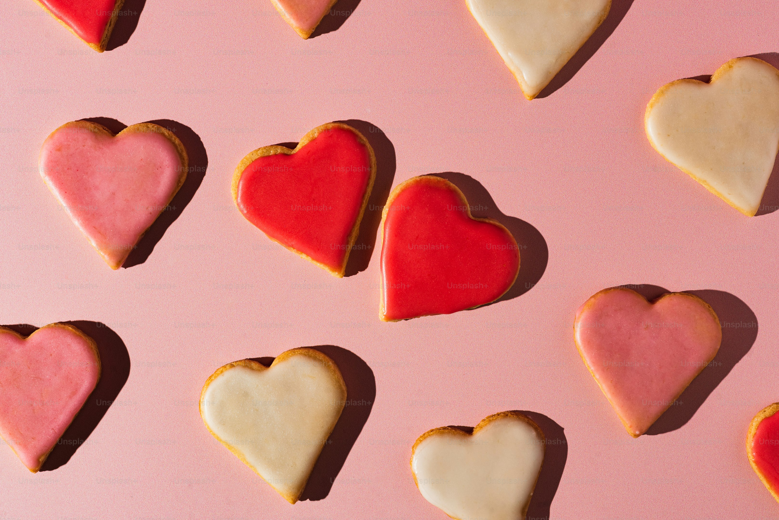 Heart shaped cookies arranged on a pink surface photo – Valentine Image ...