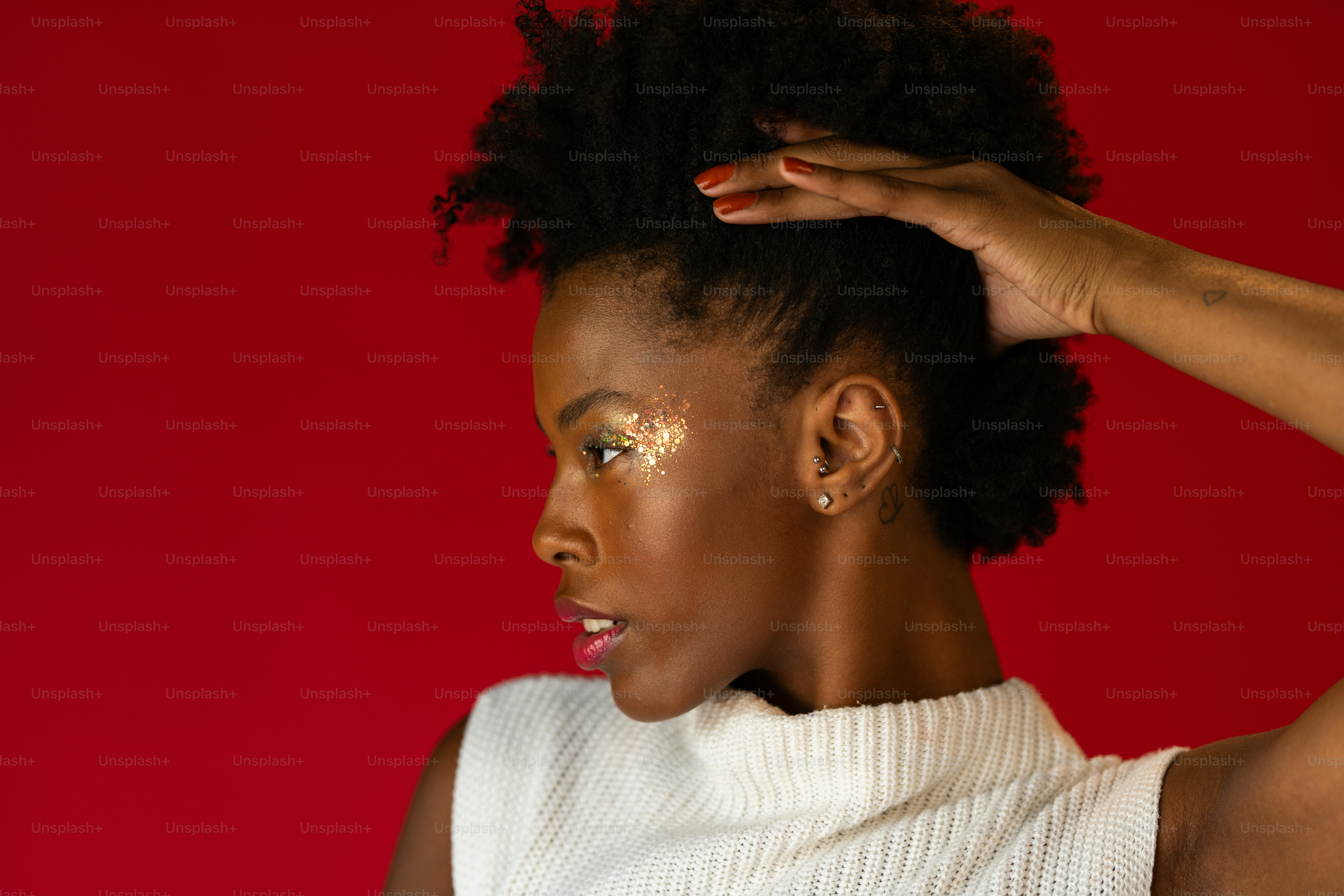 A woman in a white top is holding her hair up photo – Makeup Image on ...