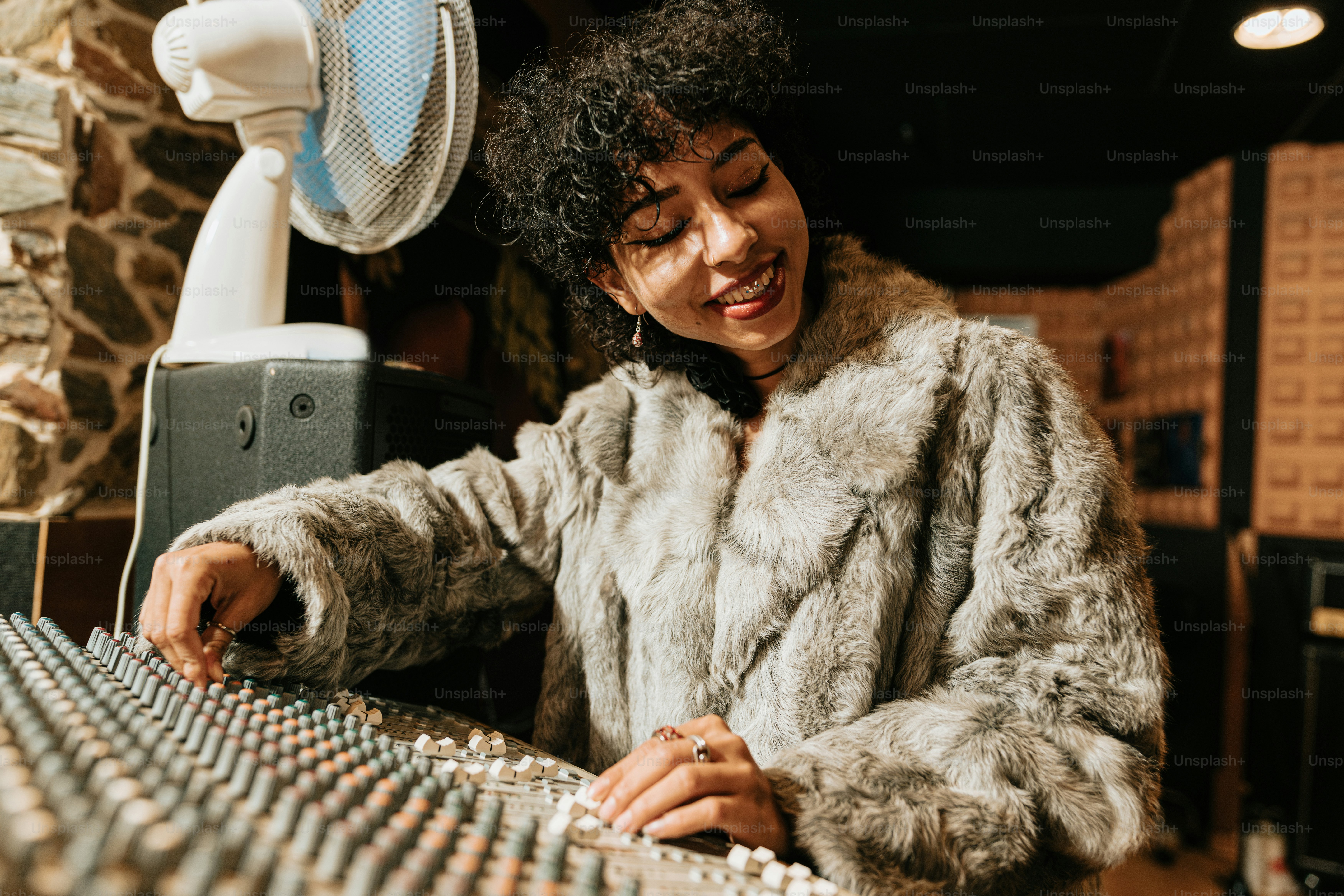A woman in a fur coat working on a machine photo – Musician Image on ...