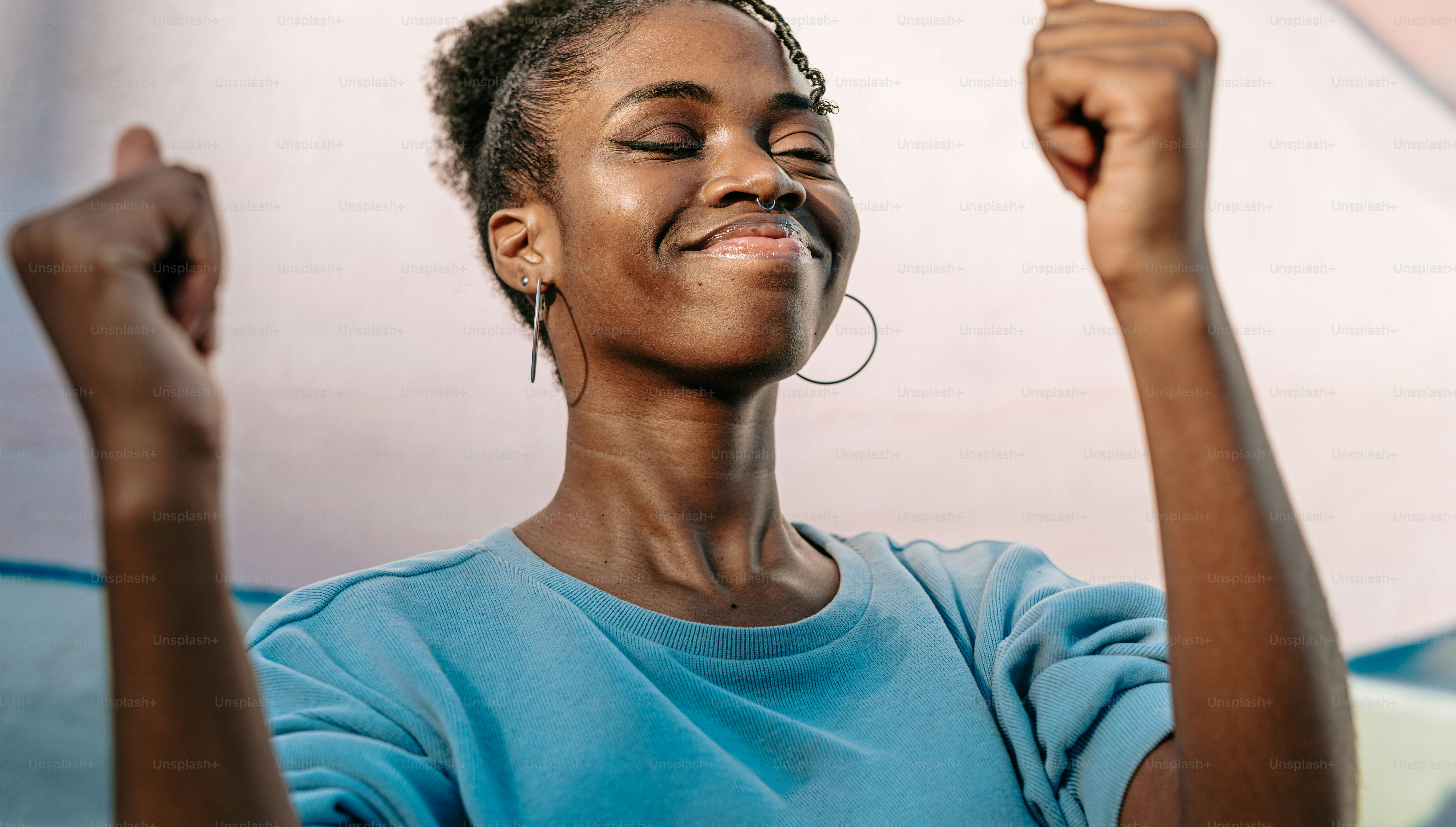 A woman raising her fist up in the air photo – Dancer Image on Unsplash