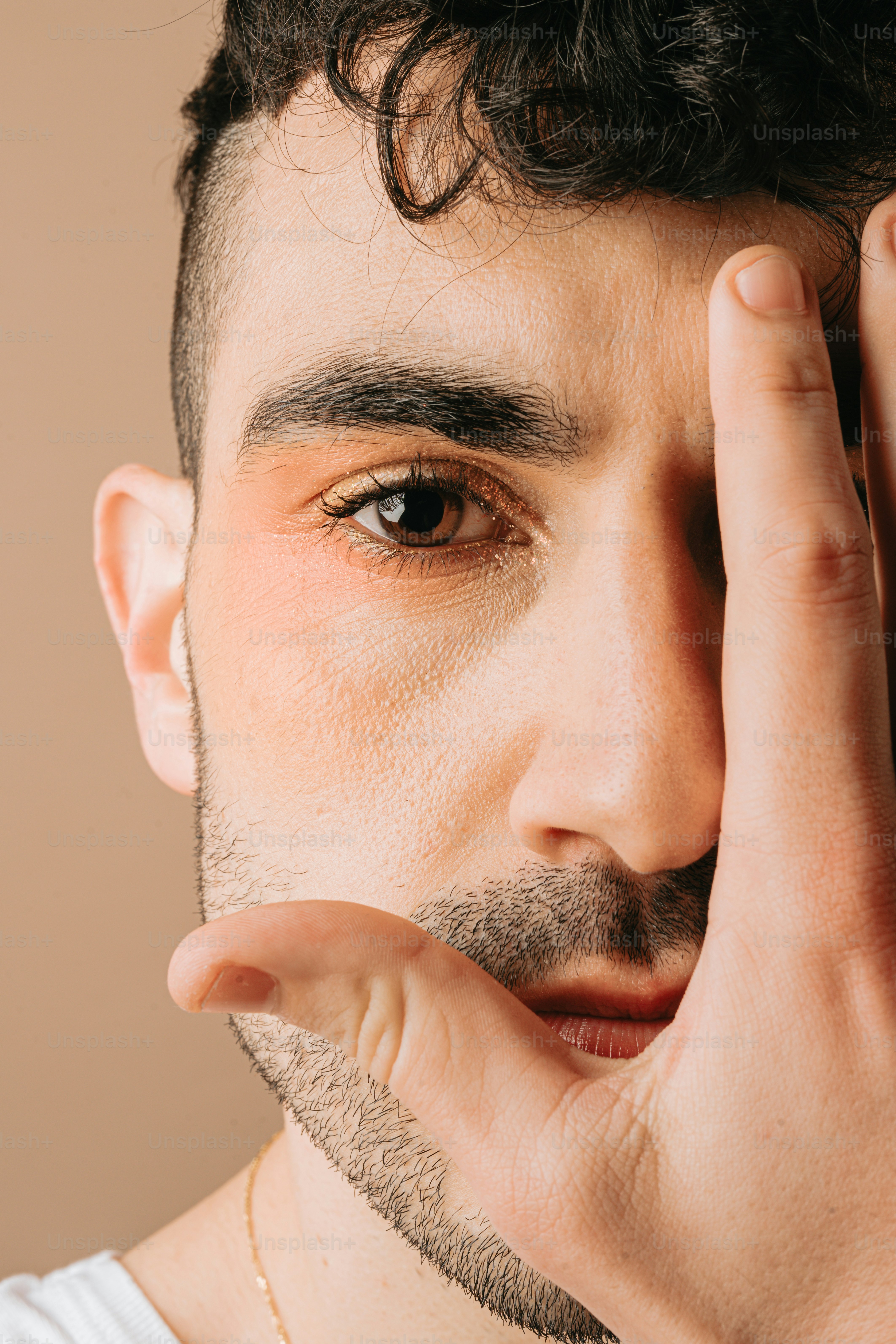 A close up of a person holding his hand to his face photo – Face Image ...