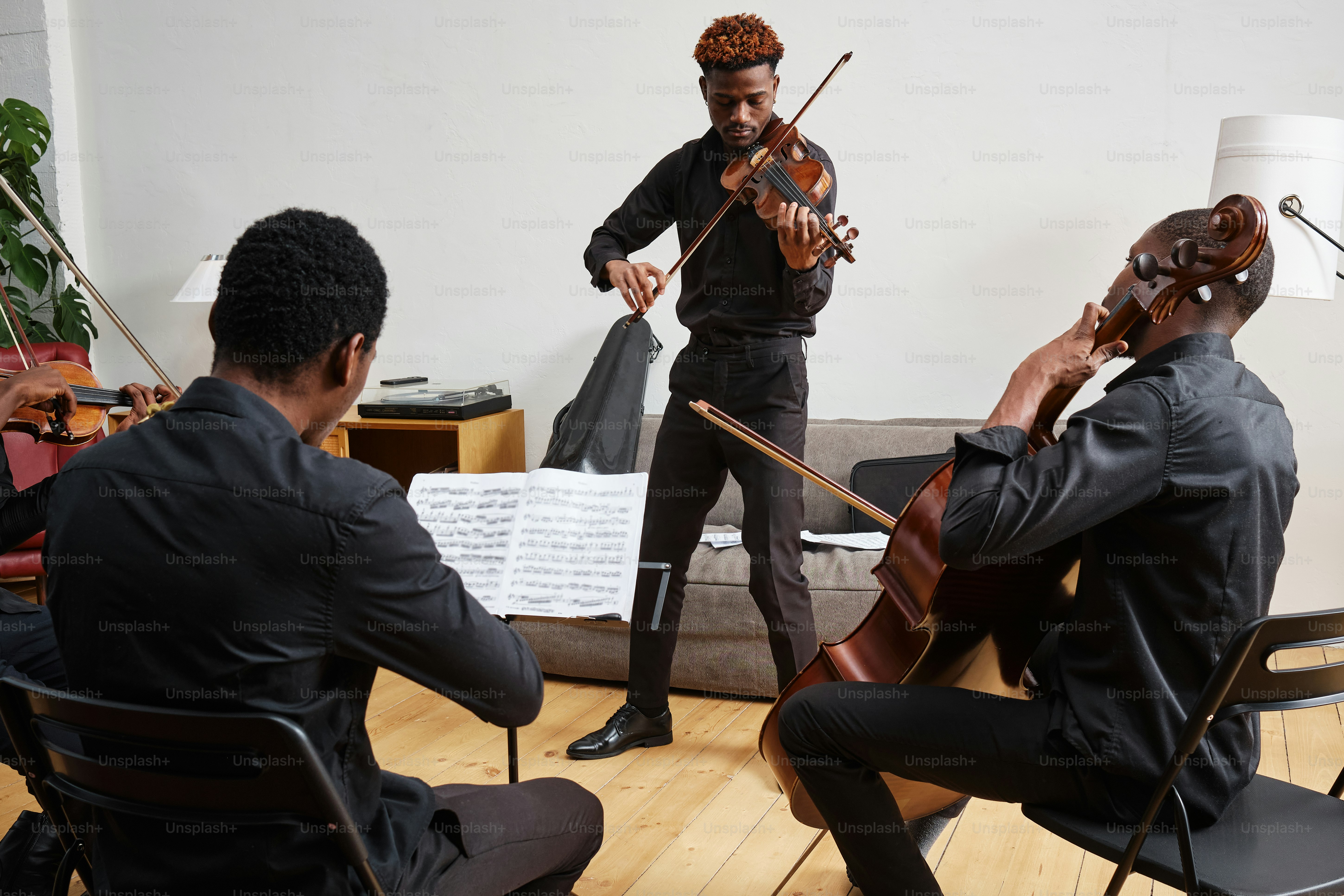 A group of men playing musical instruments in a living room photo ...
