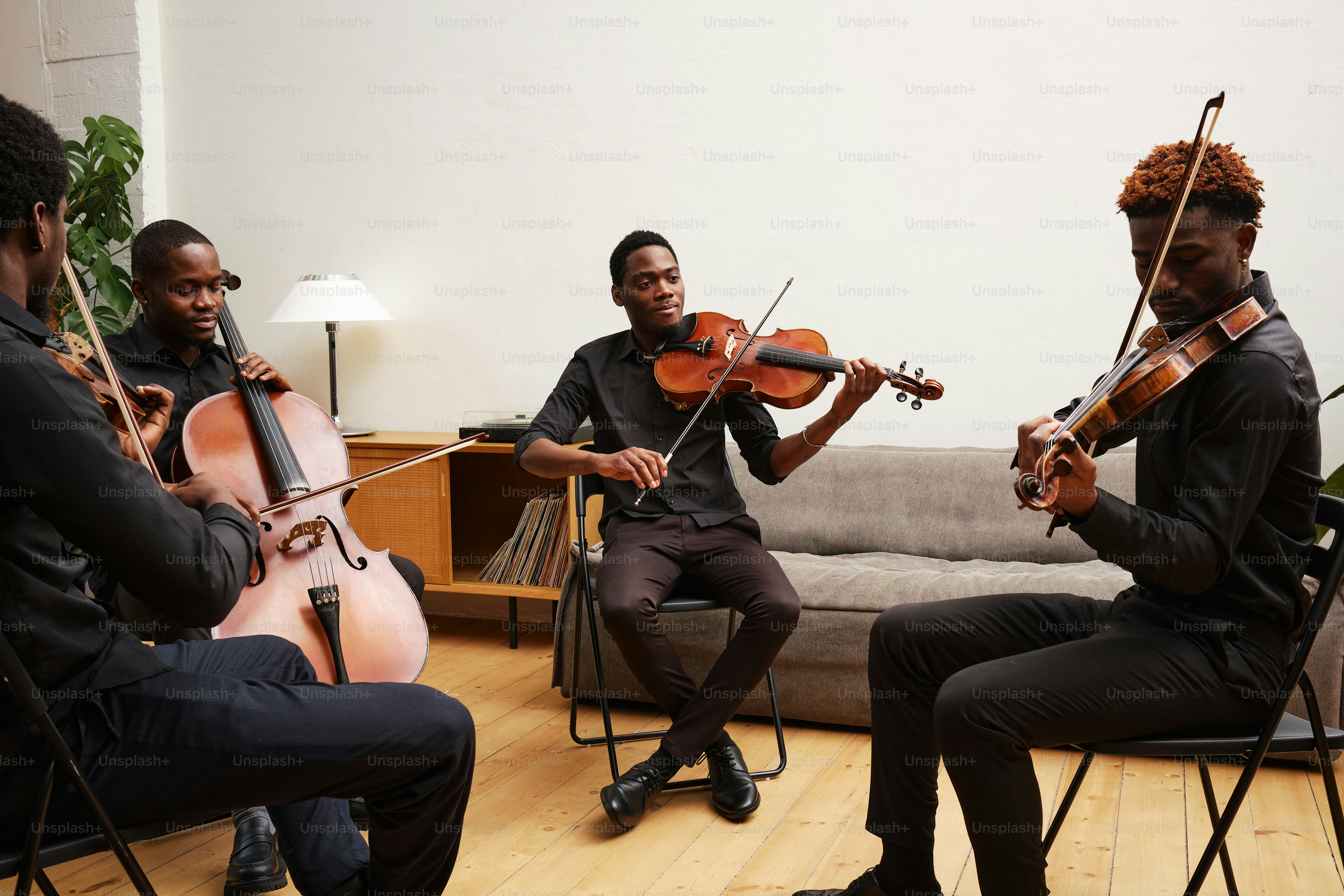 A group of men playing musical instruments in a living room photo ...