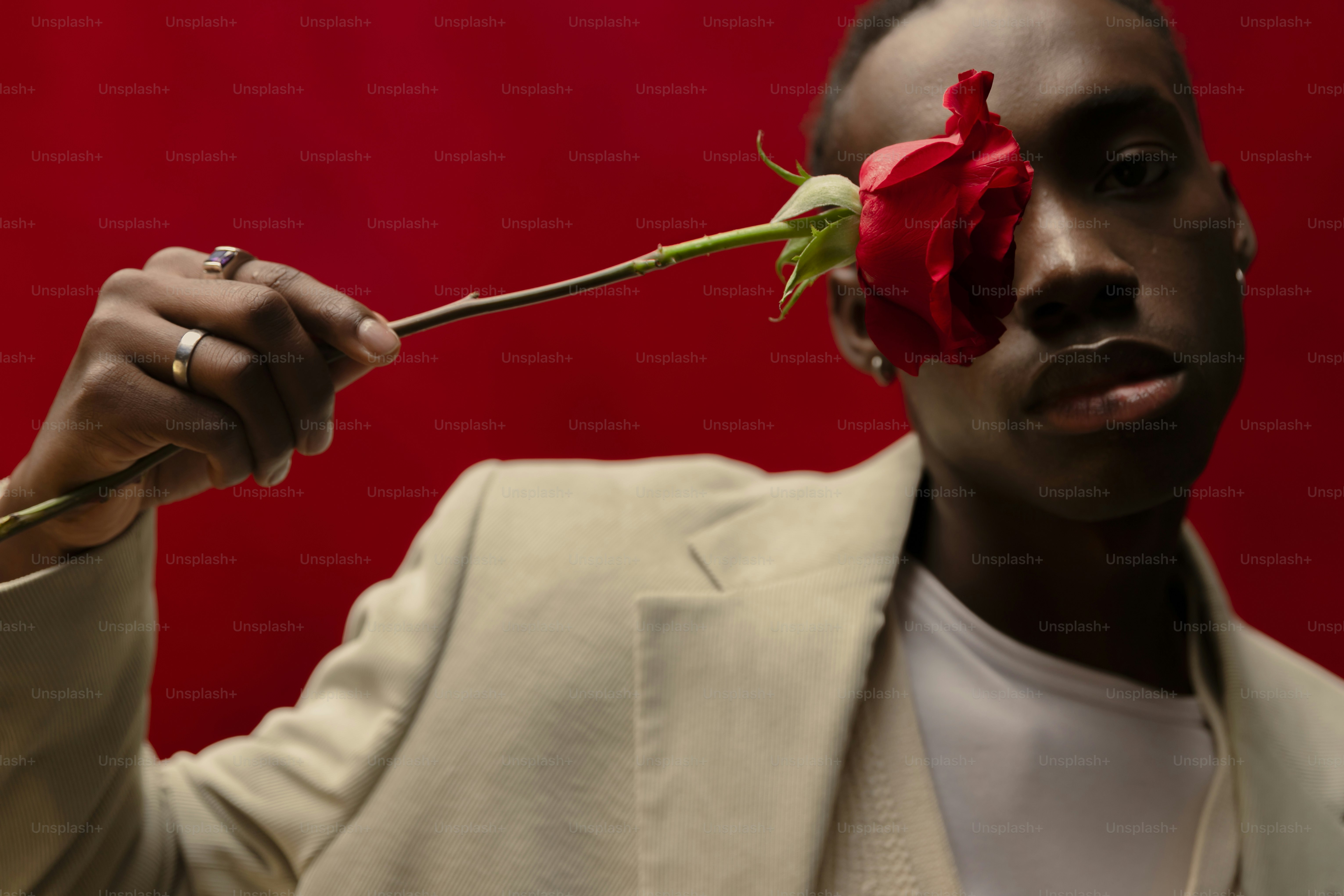 A man with a rose in his mouth photo – Single rose Image on Unsplash