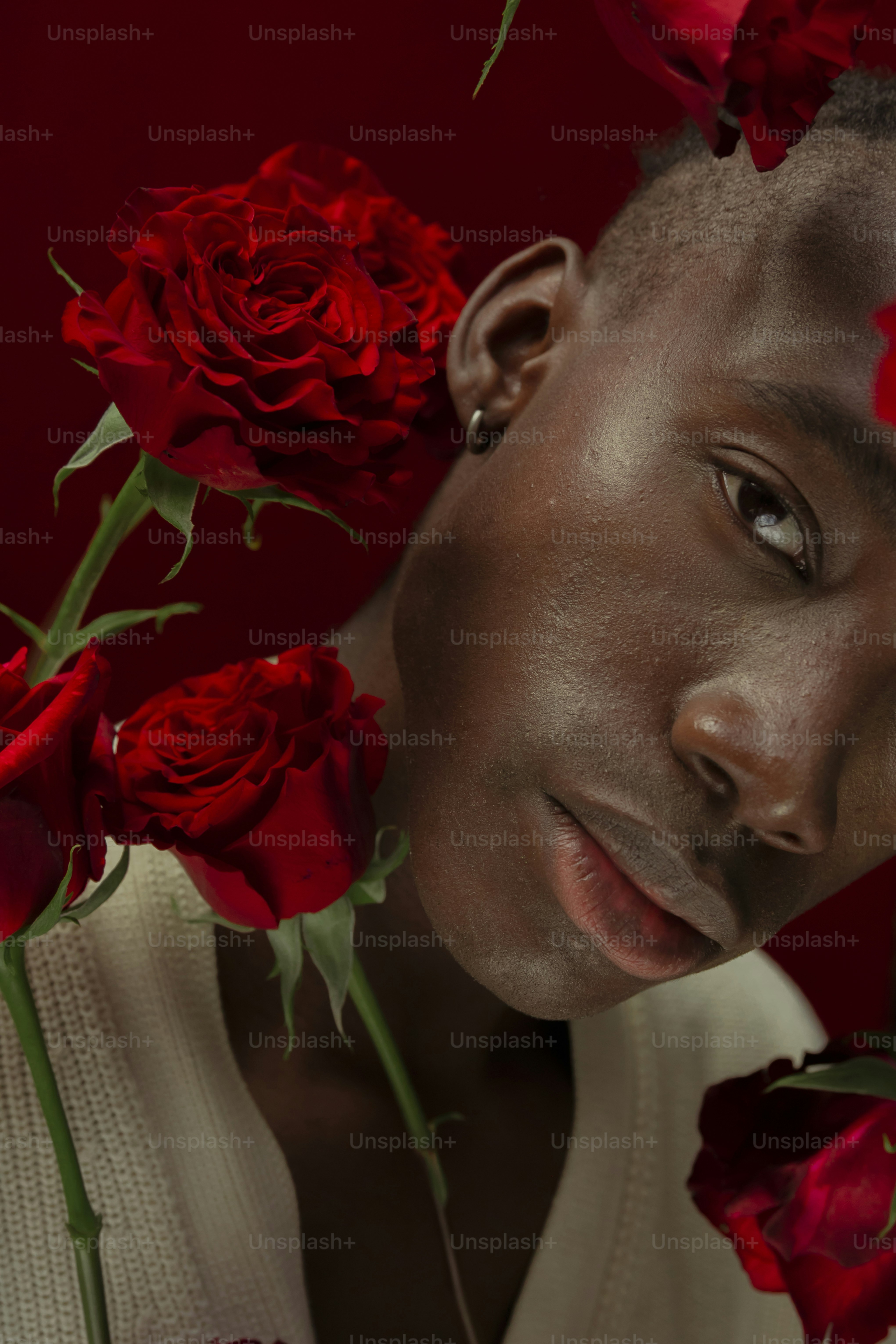 A man with a bunch of roses around his neck photo – Rose flower Image ...