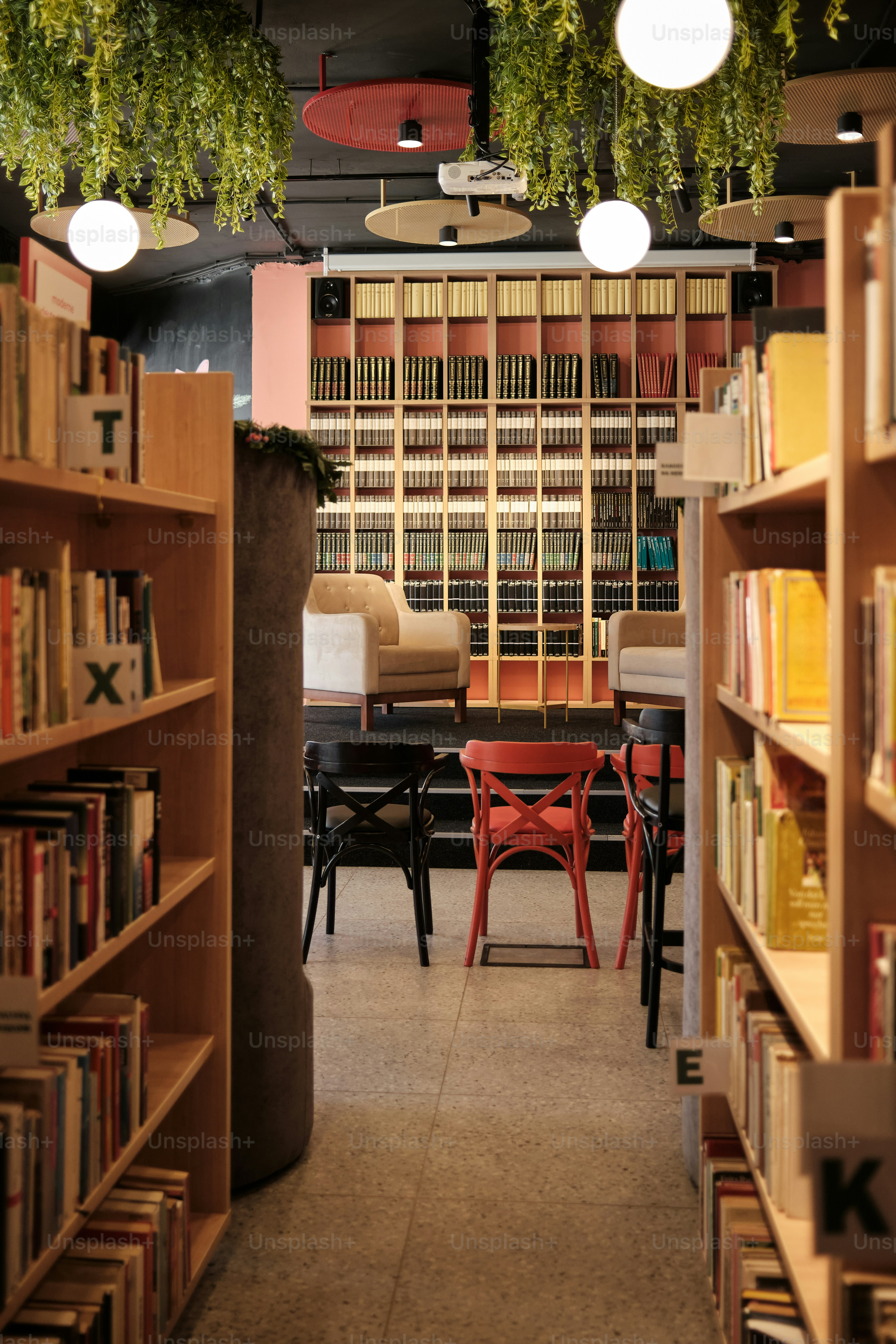 Elegant reading room with library and armchair for relaxing. space for ...