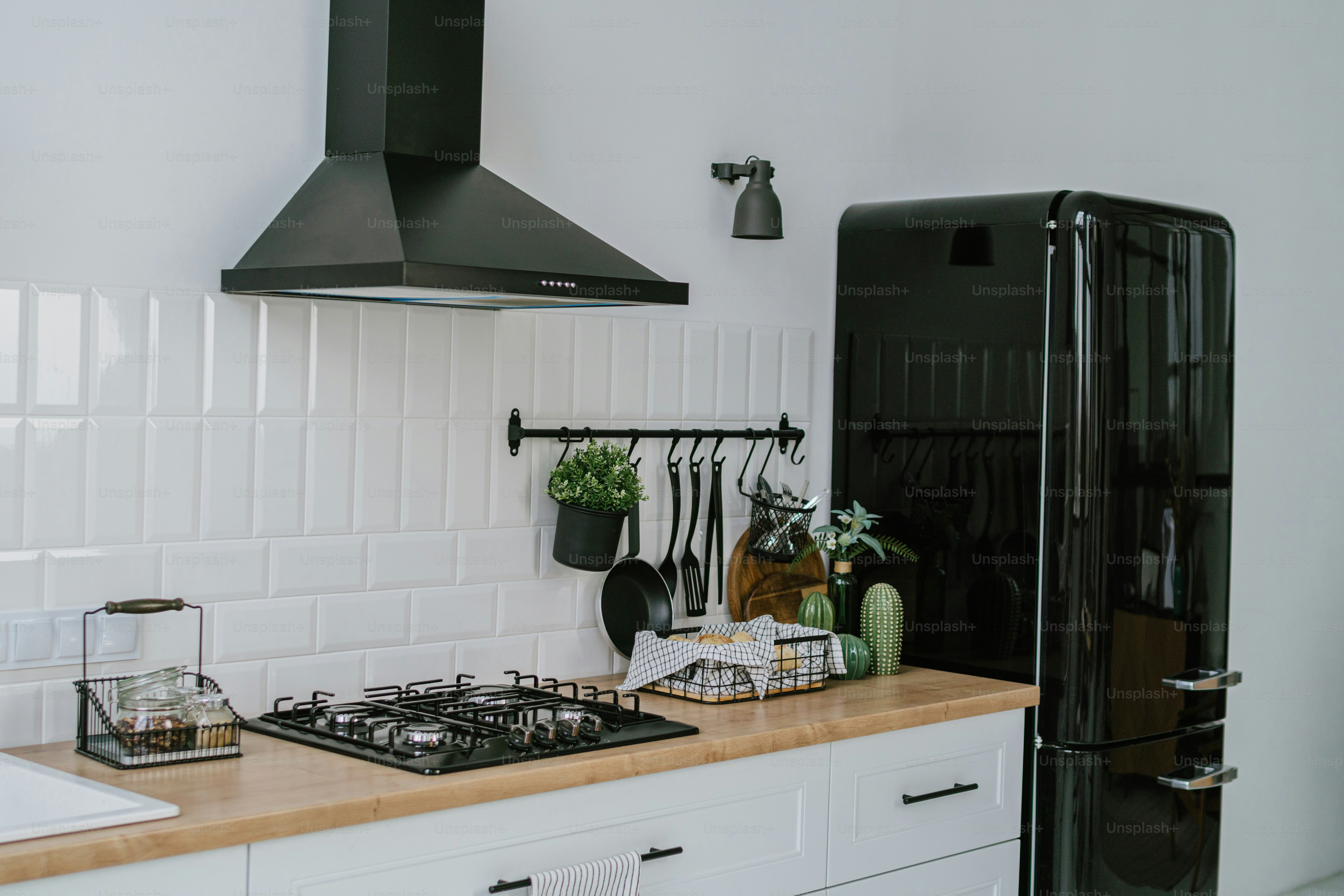A black refrigerator freezer sitting inside of a kitchen photo ...
