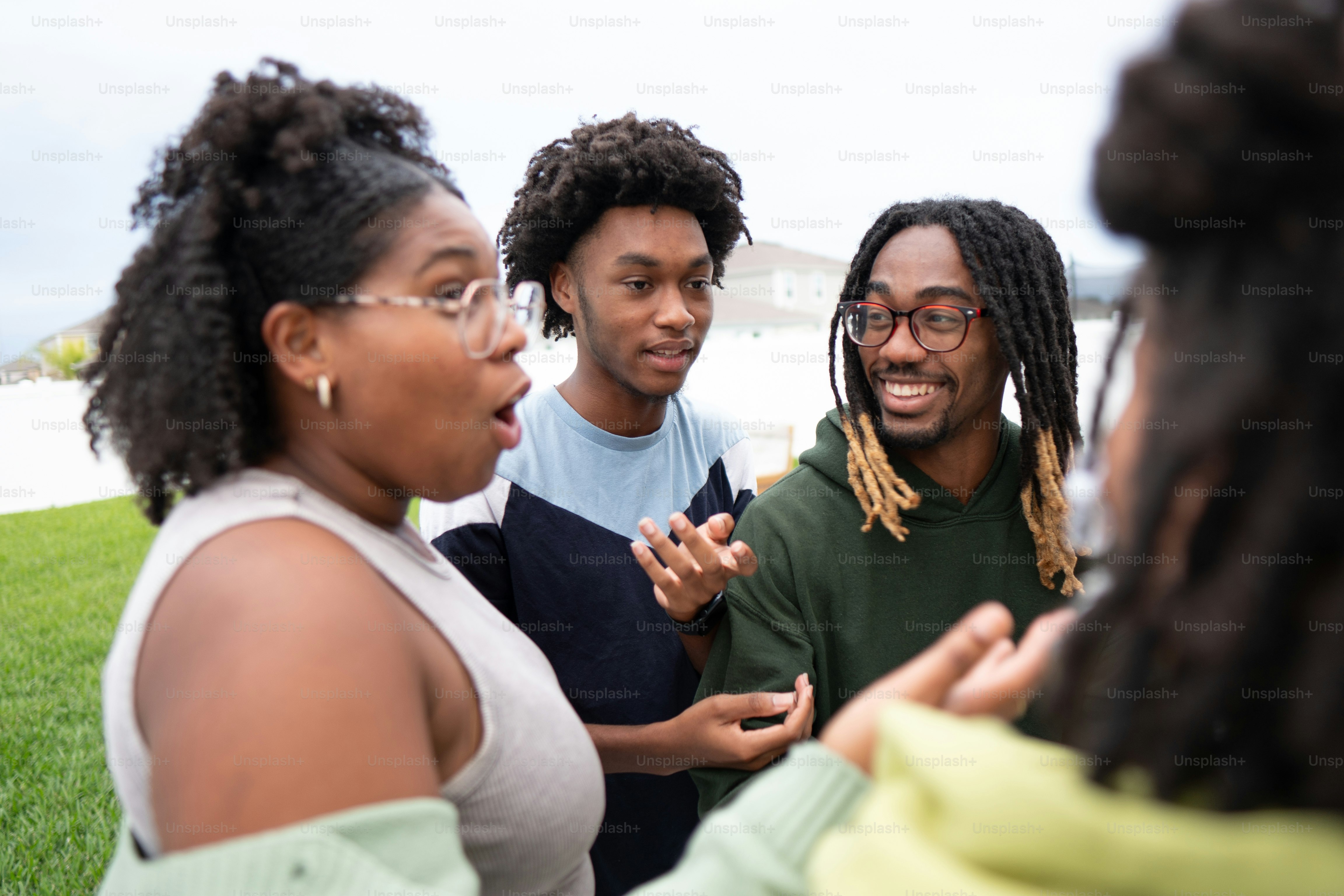 A group of people standing around each other photo – Group of friends ...