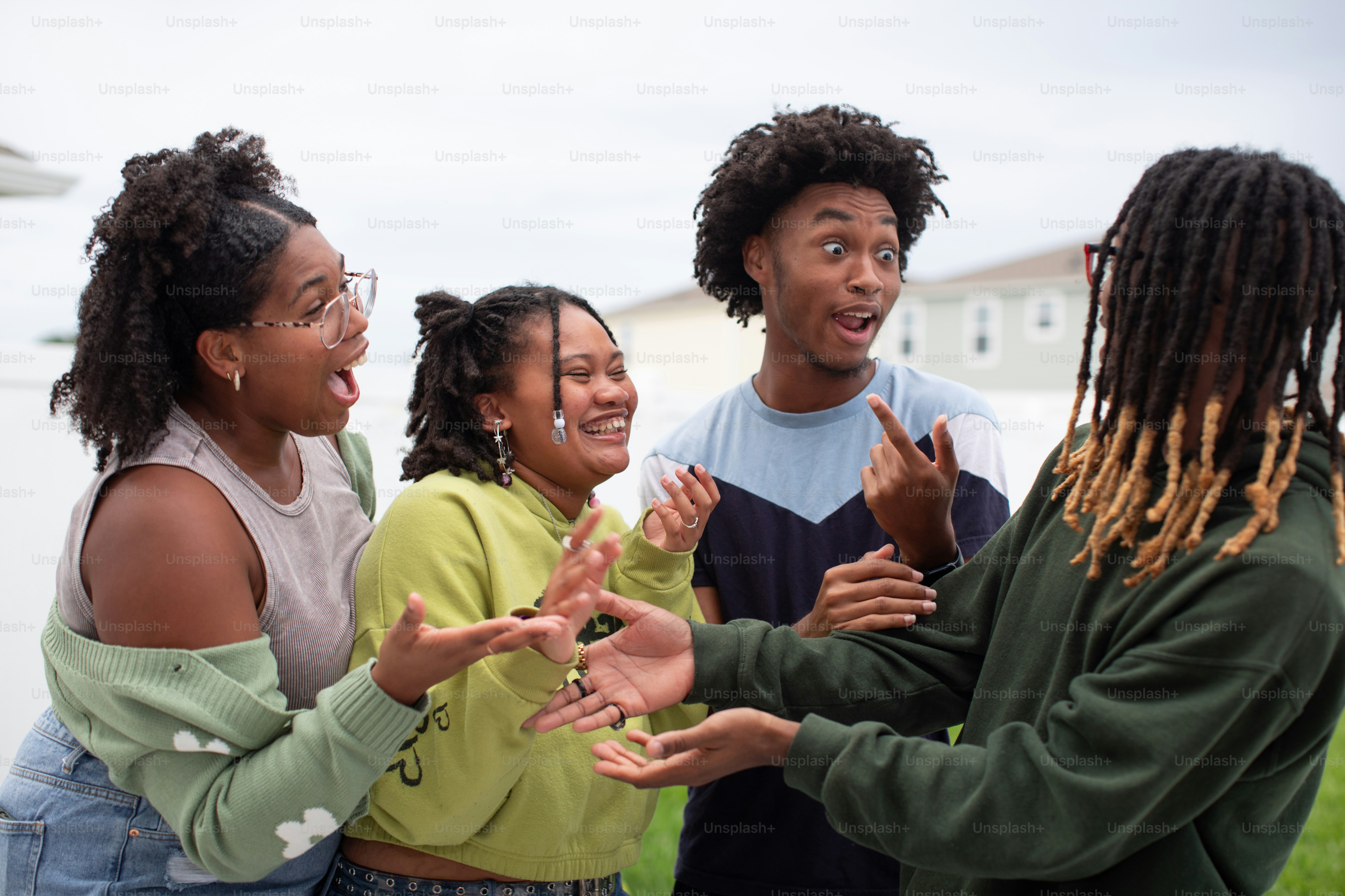 A group of people standing around each other photo – Teenagers Image on ...