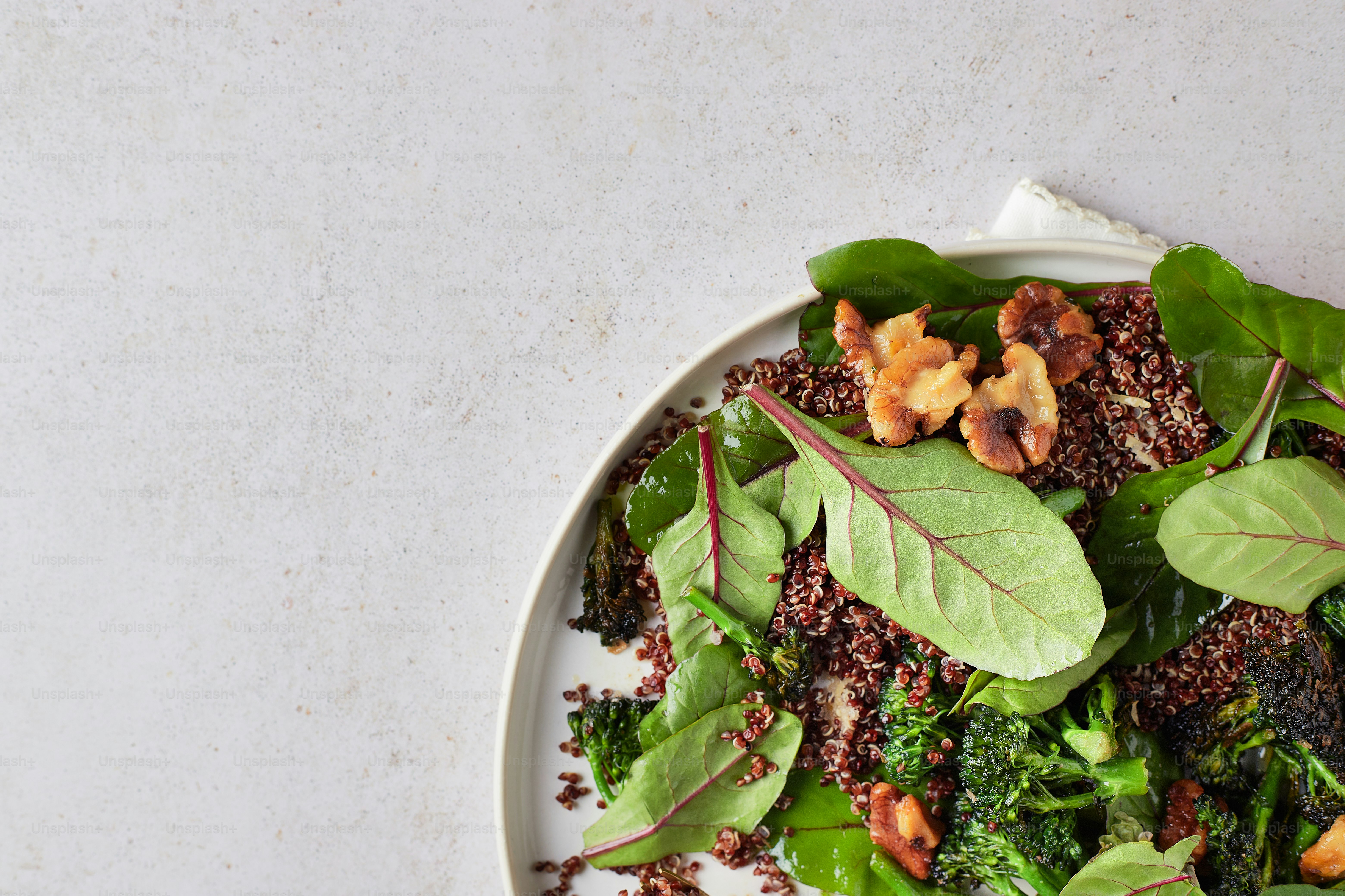 A white plate topped with a salad next to a cup of coffee photo – Food ...