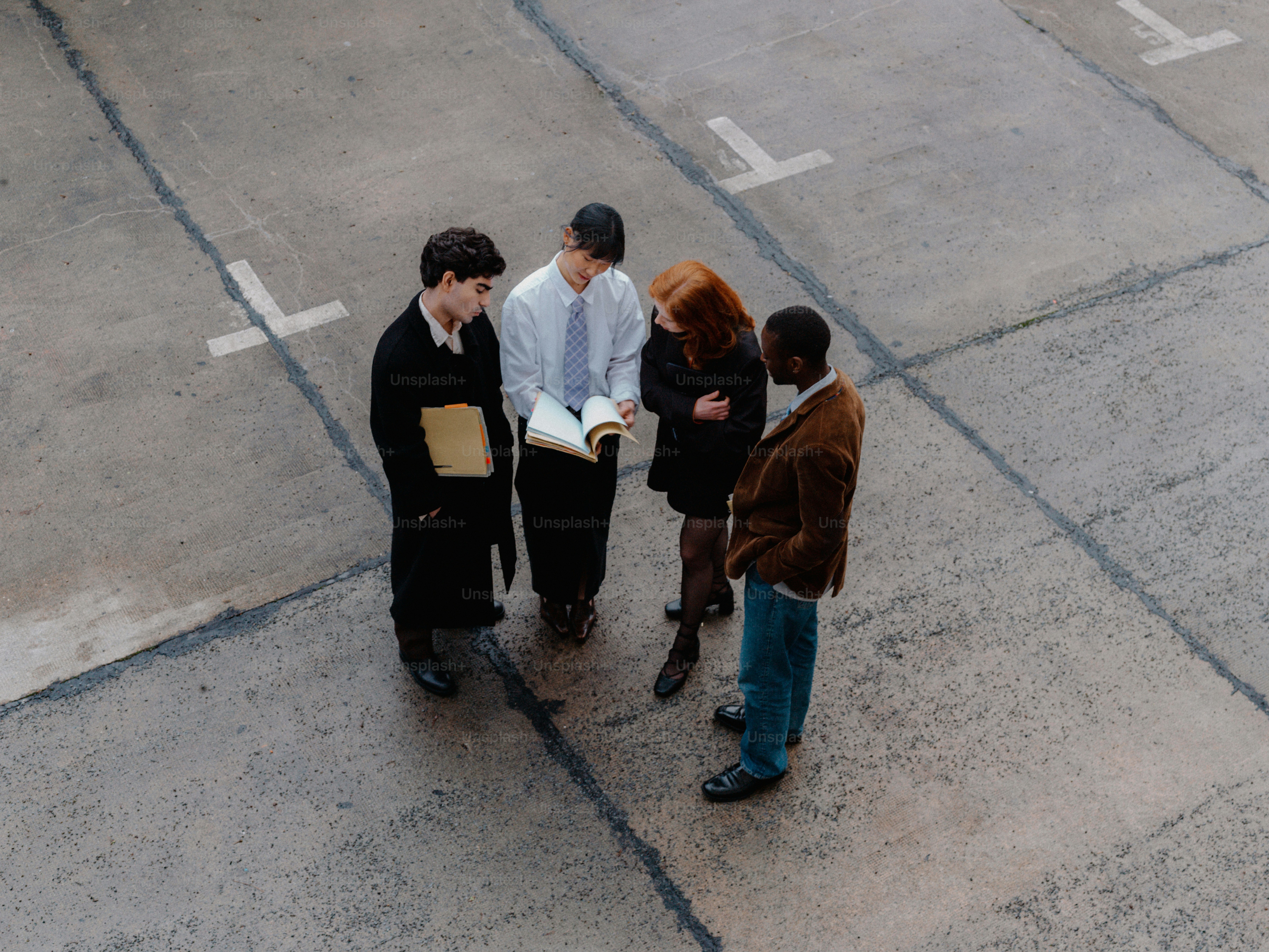 A group of people standing around each other photo – Smartly dressed ...
